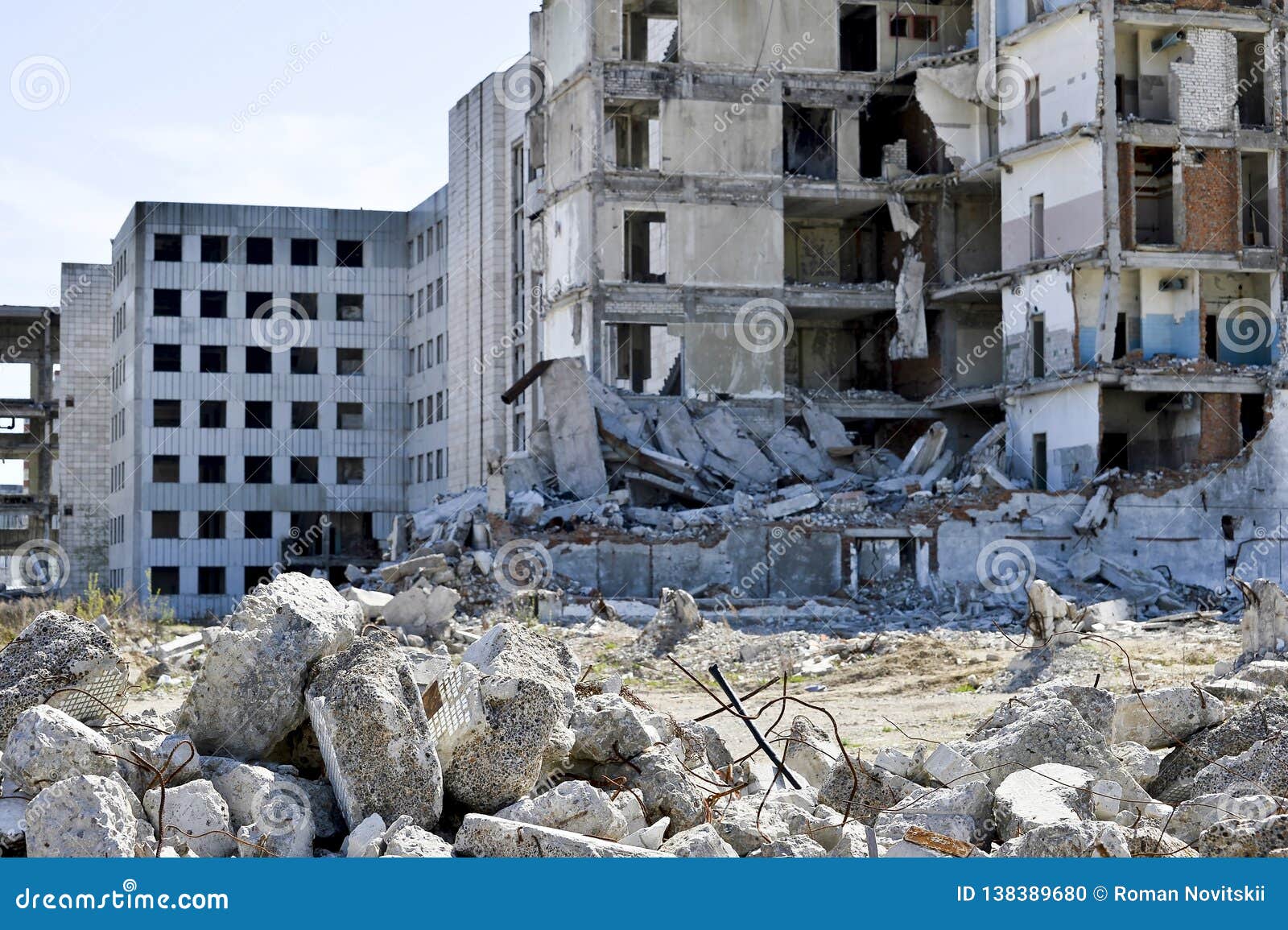 A Pile of Concrete Debris on the Background of a Large Destroyed ...