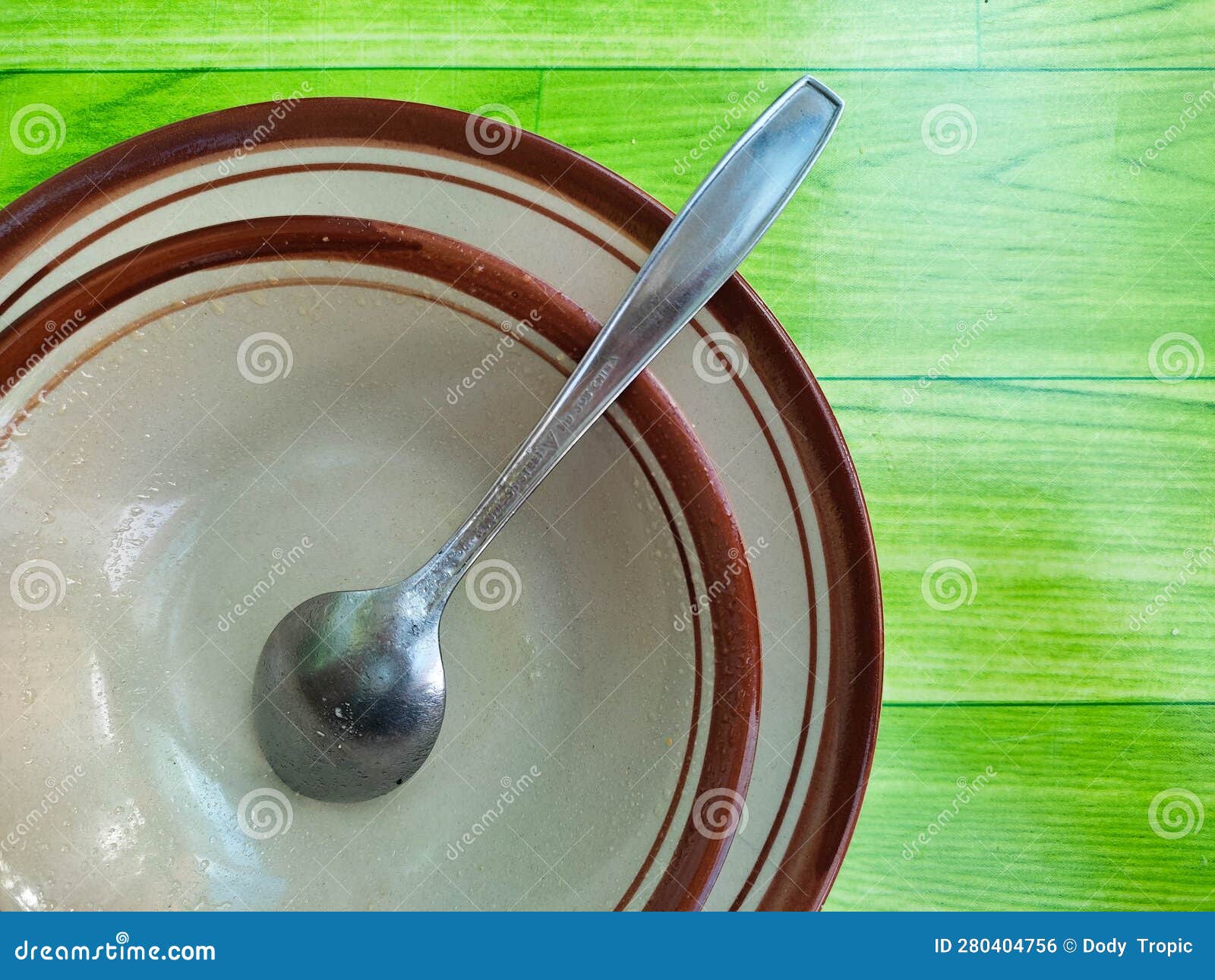 Pile of Empty Plates and Bowls with Spoons Stock Photo - Image of ...