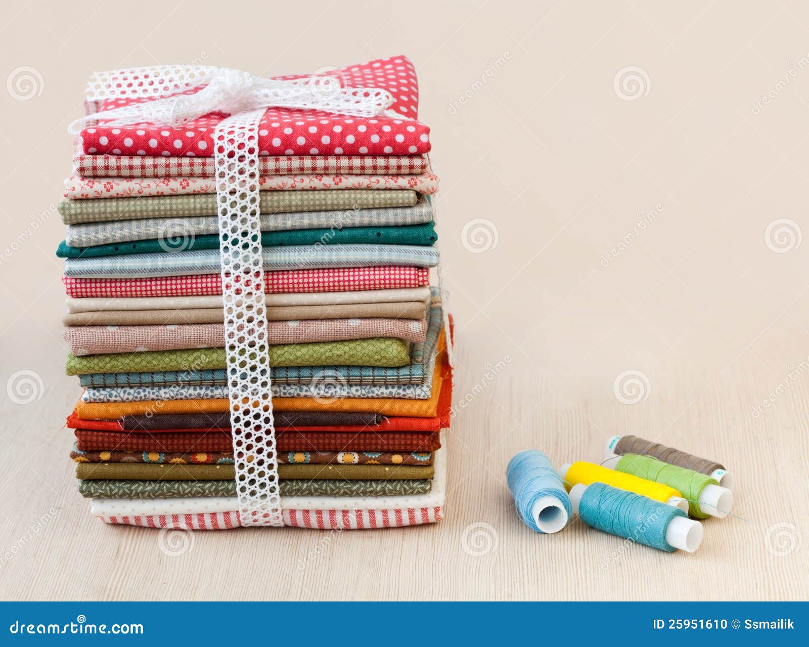 Pile of Folded Textile with Spool of Thread Stock Photo - Image of ...