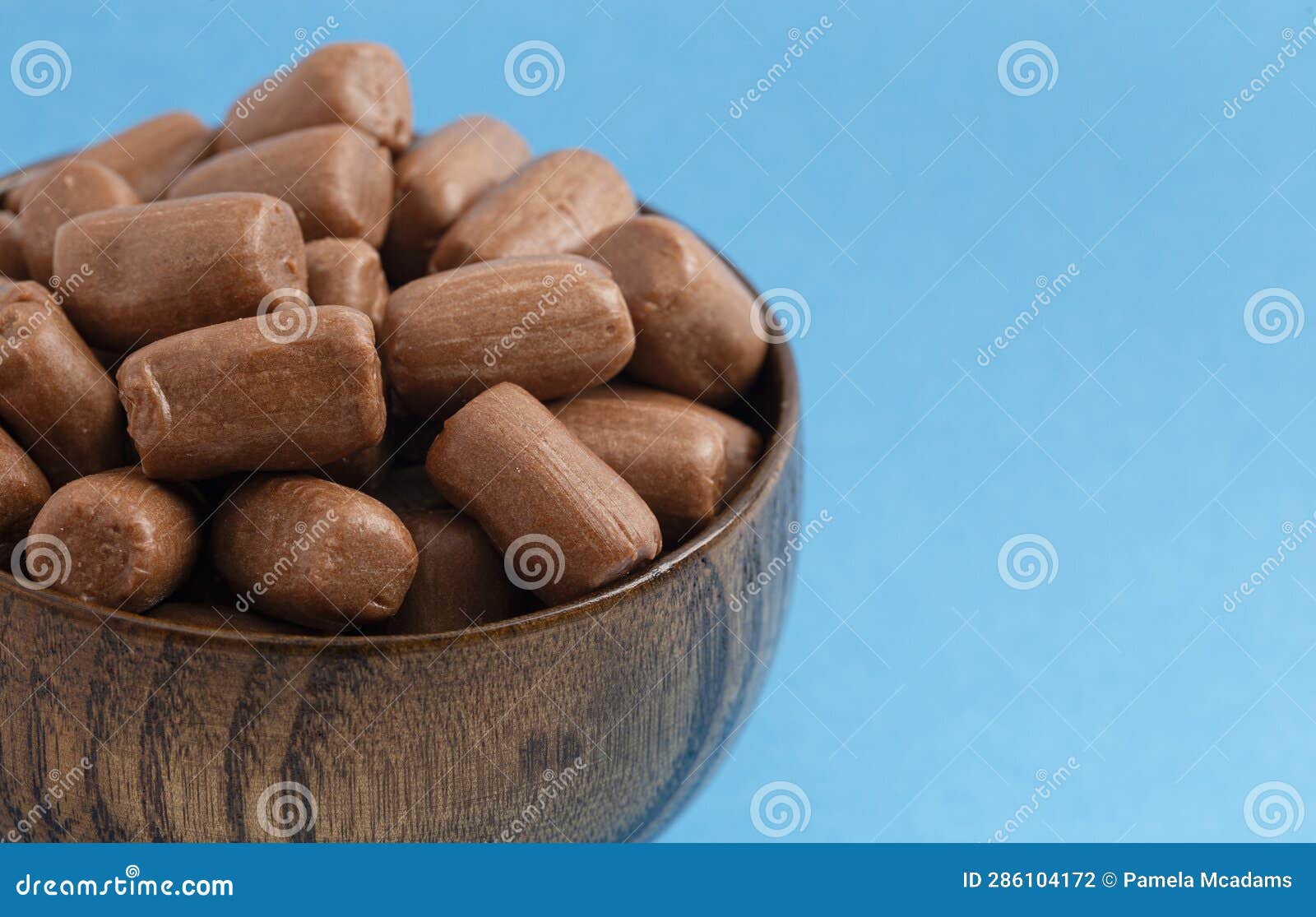 A Pile of Freeze Dried Chocolate Candy Rolls Isolated on a Blue ...