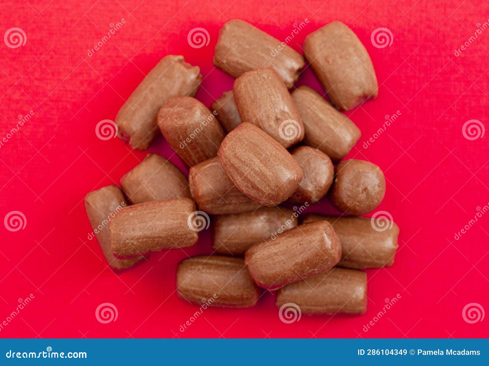 Pile of Freeze Dried Chocolate Candy Rolls Isolated on a Red Background ...