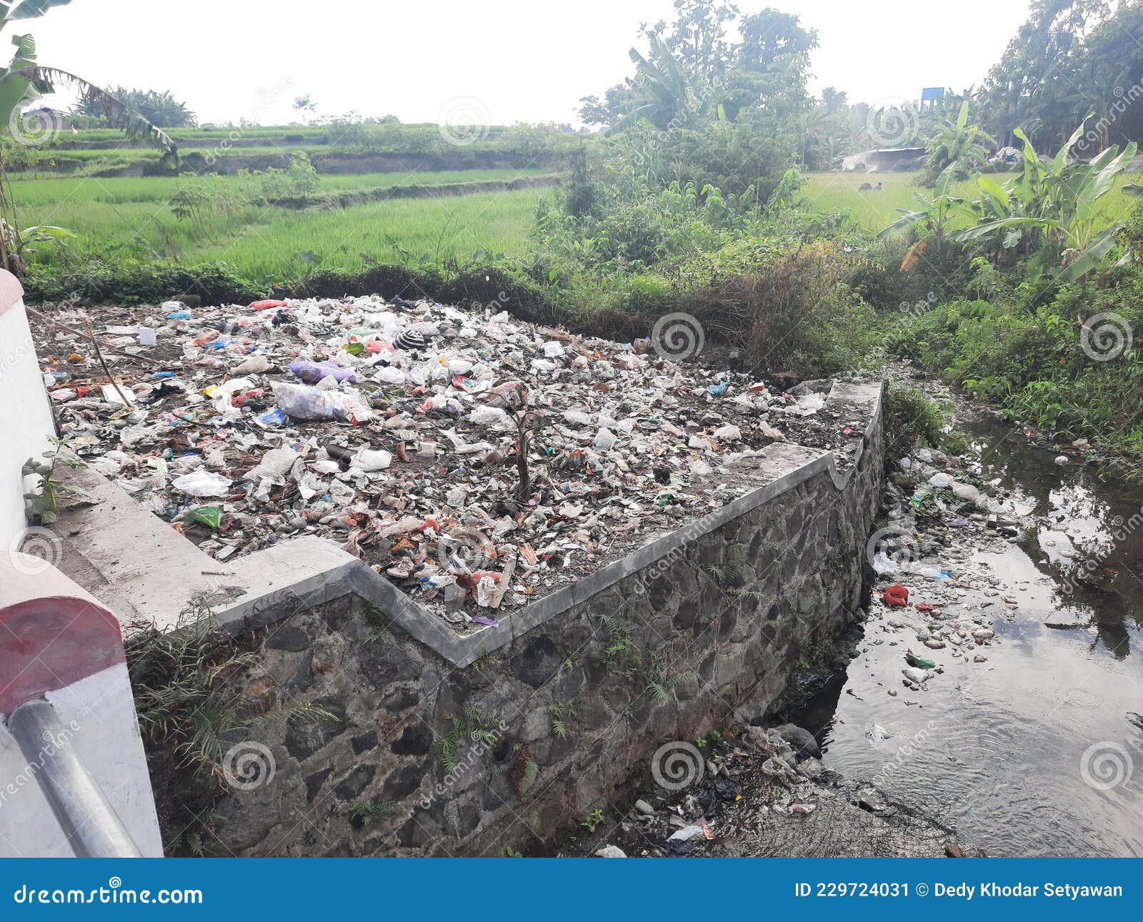 Pile Of Garbage On Rhe Edge Of The River Bridge Royalty-Free Stock ...