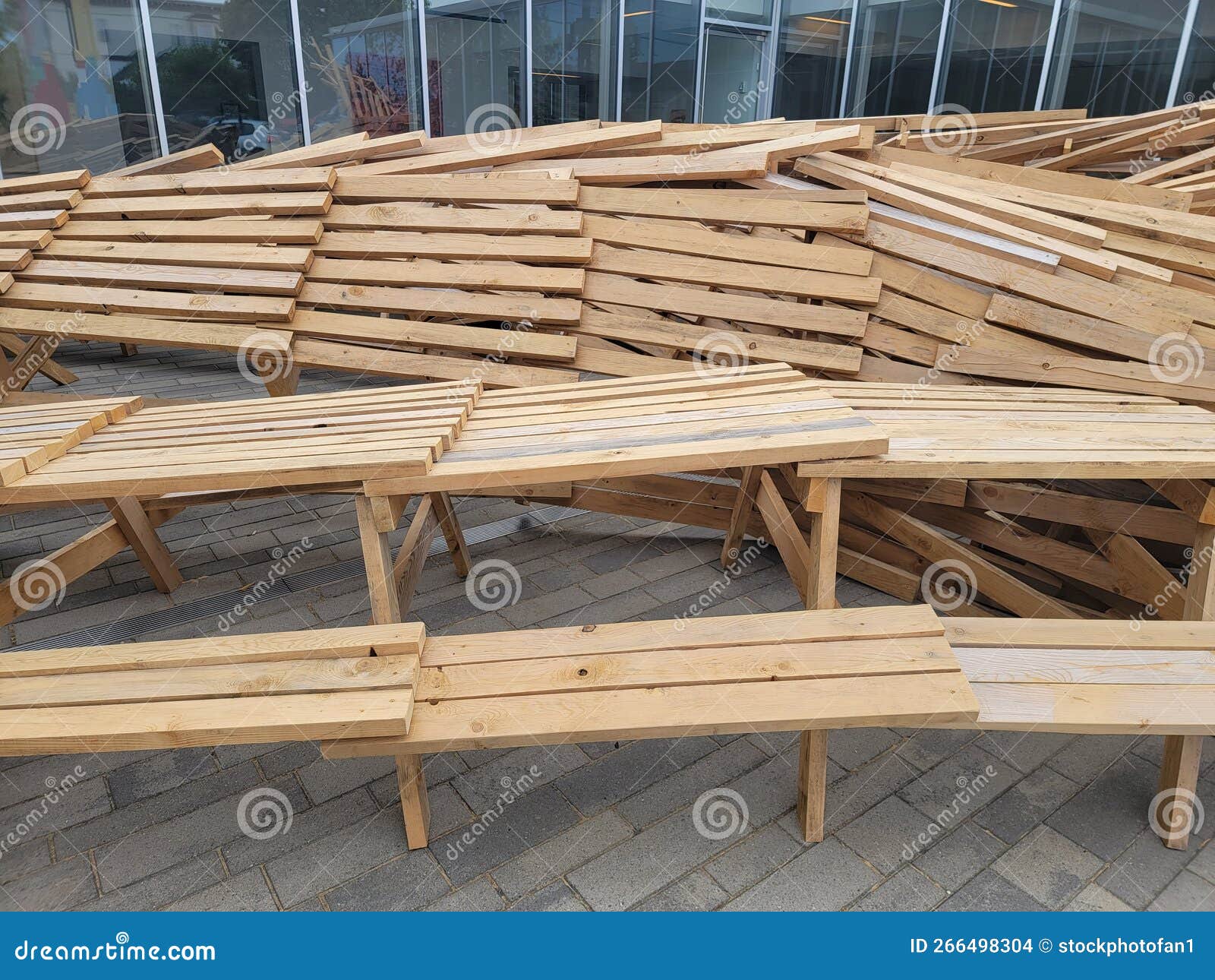 Pile or Mound of Wood Tables Outside Building with Windows Stock Photo ...