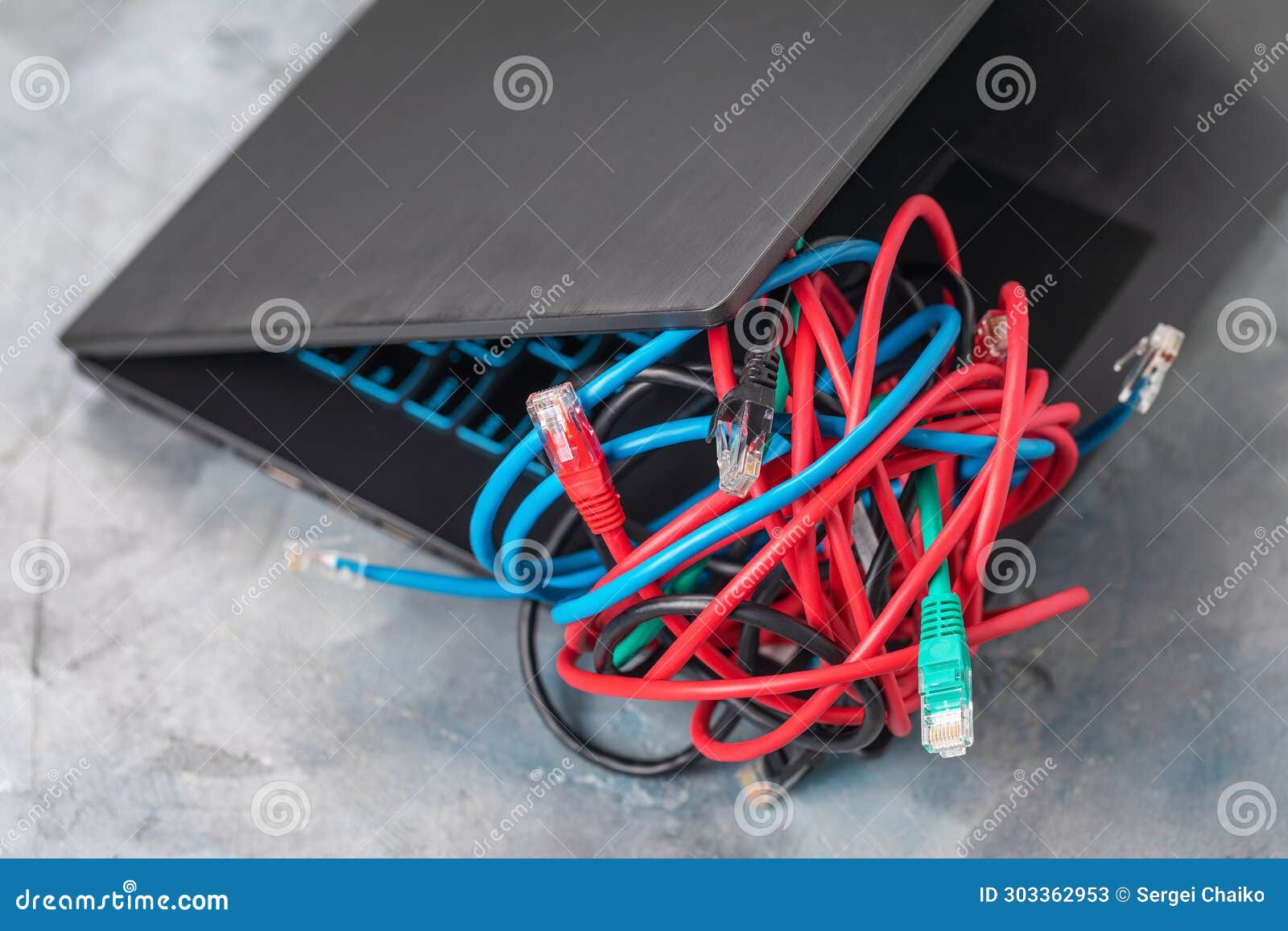 A Pile of Network Wires and a Laptop on the Table, a Concept on the ...
