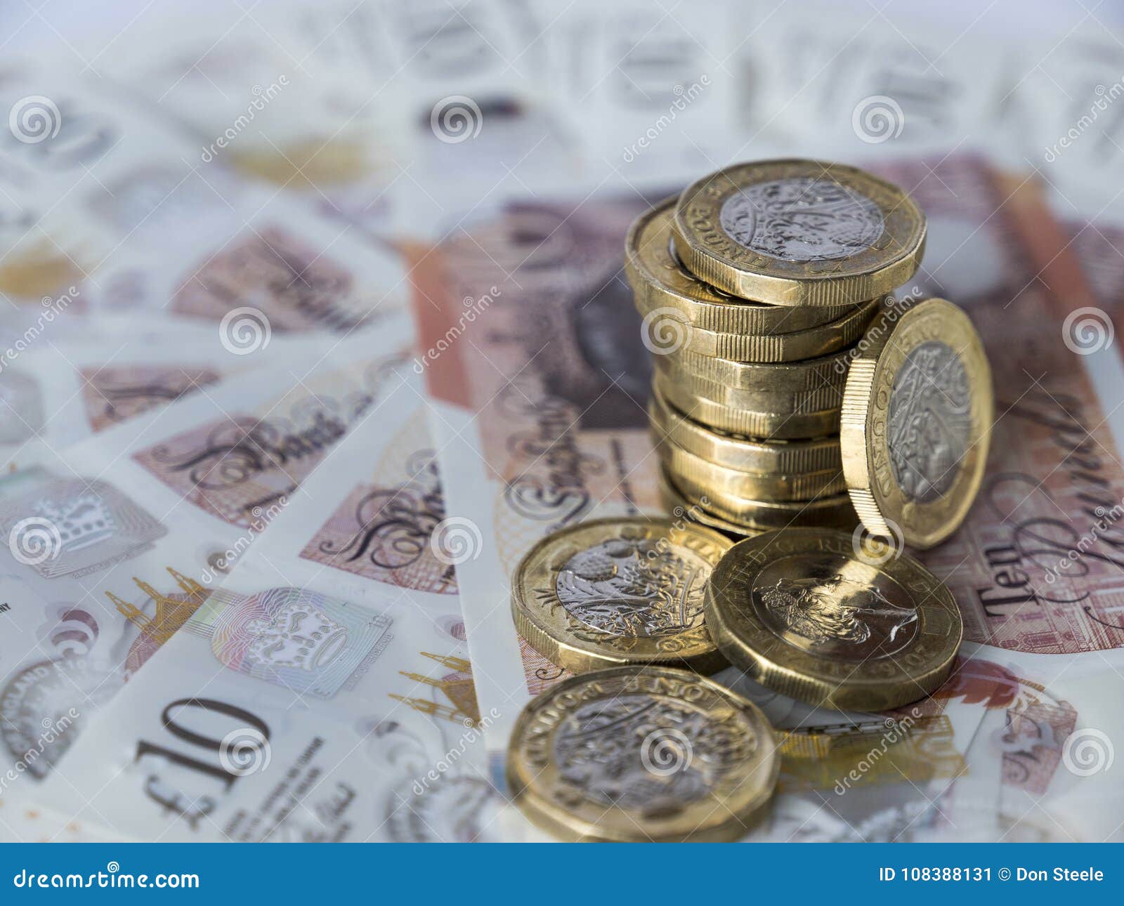 Stack of New Pound Sterling Coins on Semi Circle of Ten Pound Notes ...