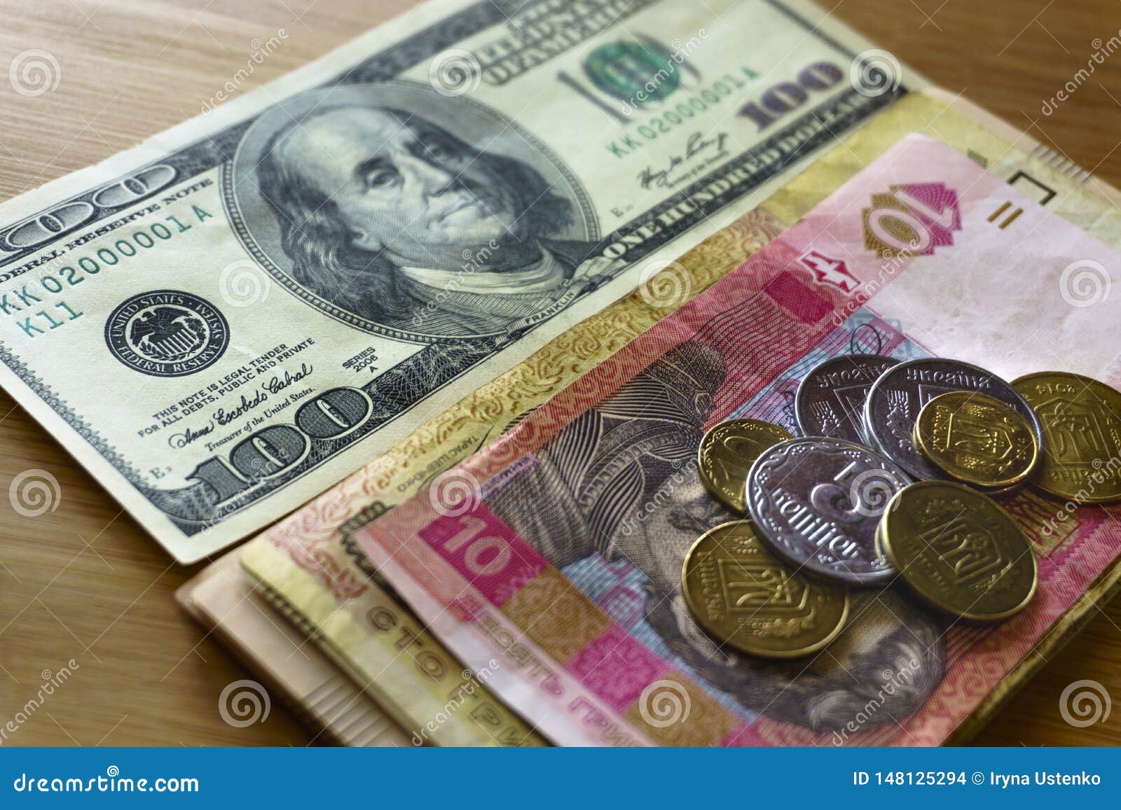 Ukrainian Metal Coins of 1, 2 Hryvnias Stacked Against 100 American ...