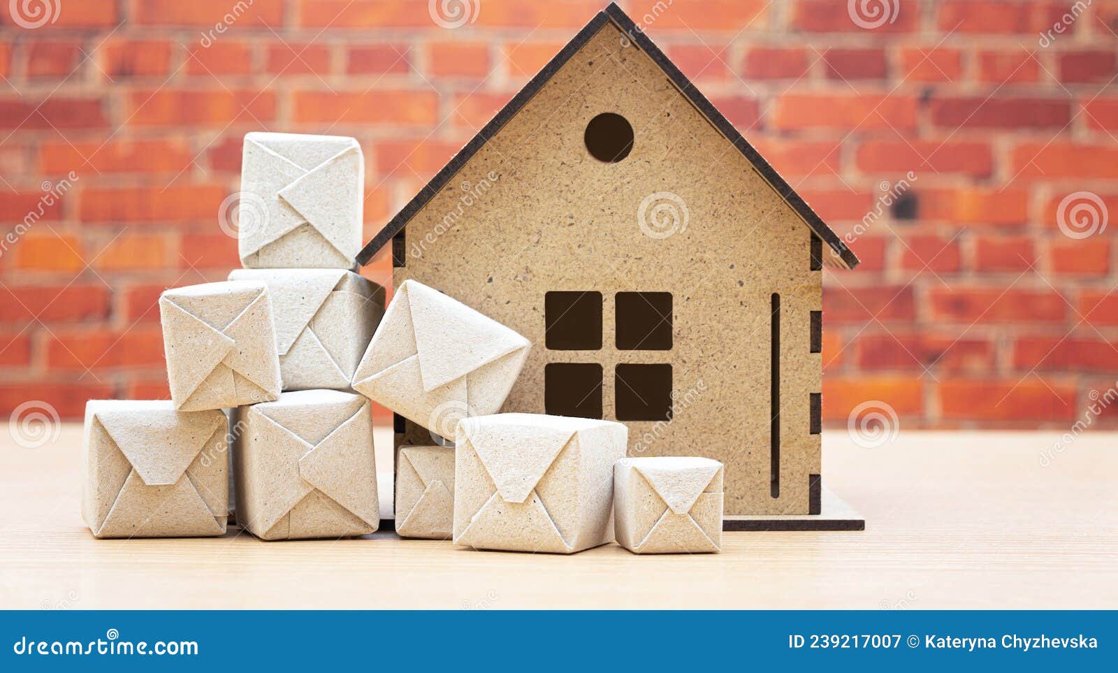 Pile of Packages by a House Model Against a Brick Wall Stock Image ...