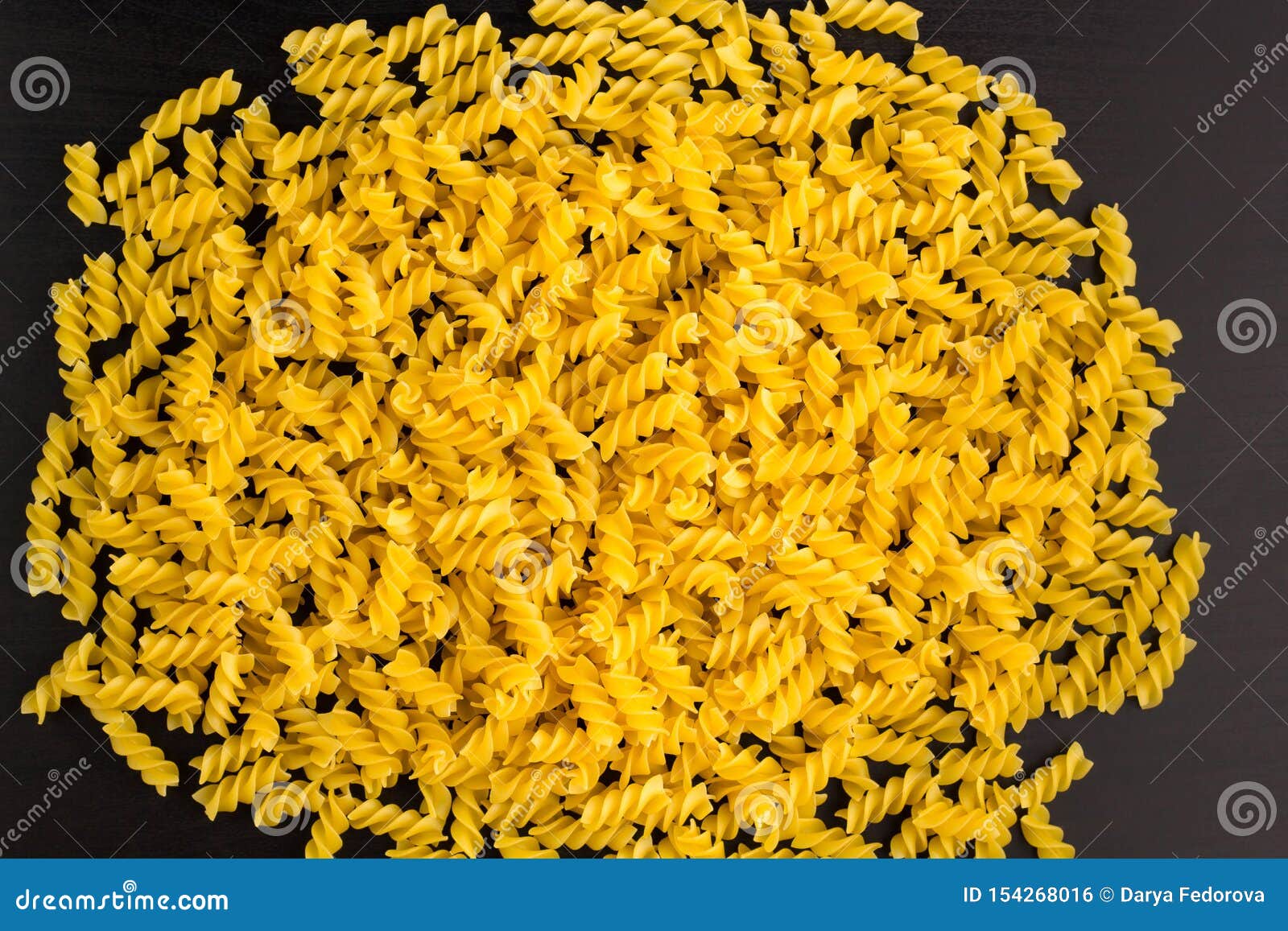 A Pile of Pasta Spiral Fusilli on Black Background Stock Photo - Image ...