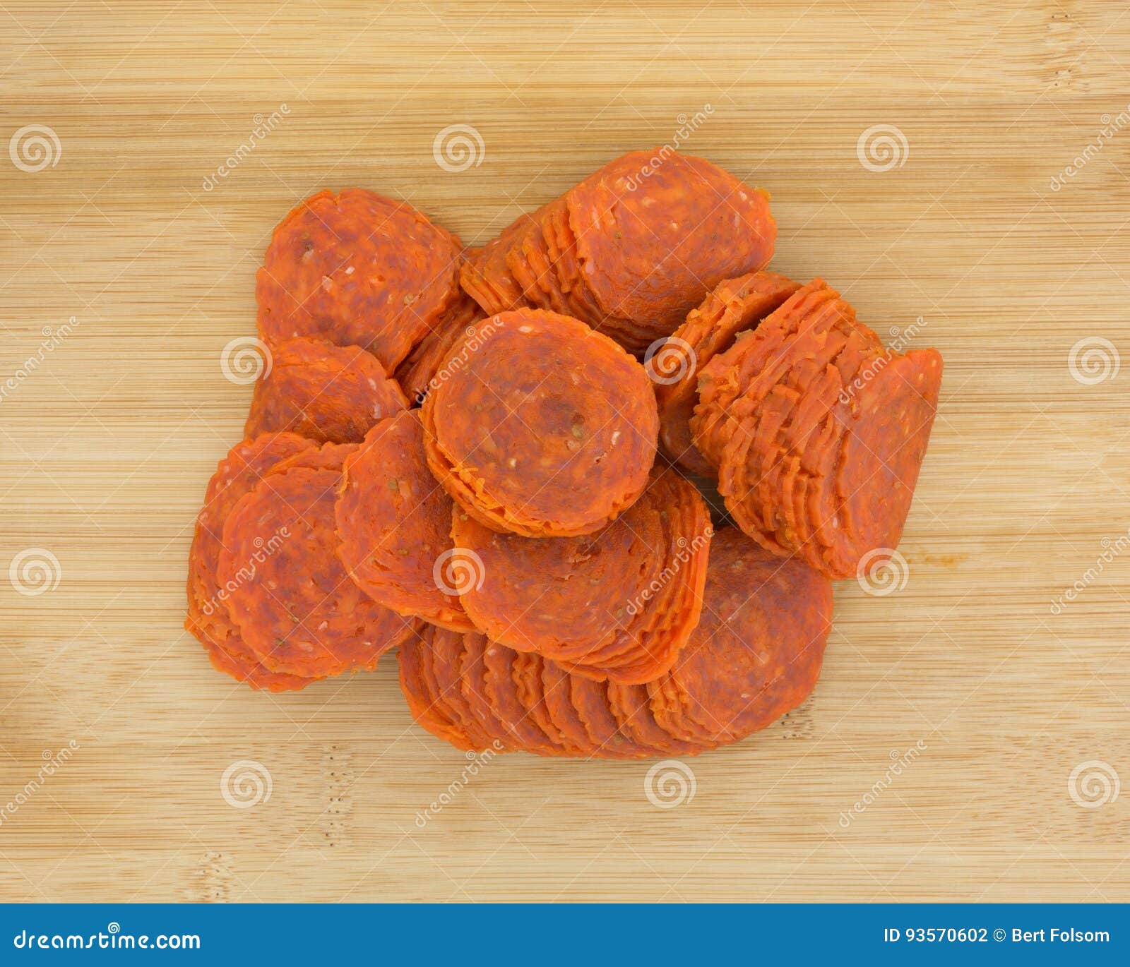Pile of Pepperoni Slices on a Wood Cutting Board Stock Photo - Image of ...
