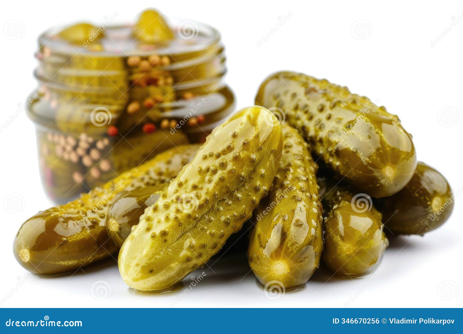 A Pile of Pickles Sits Next To an Open Jar of Pickles Stock Photo ...