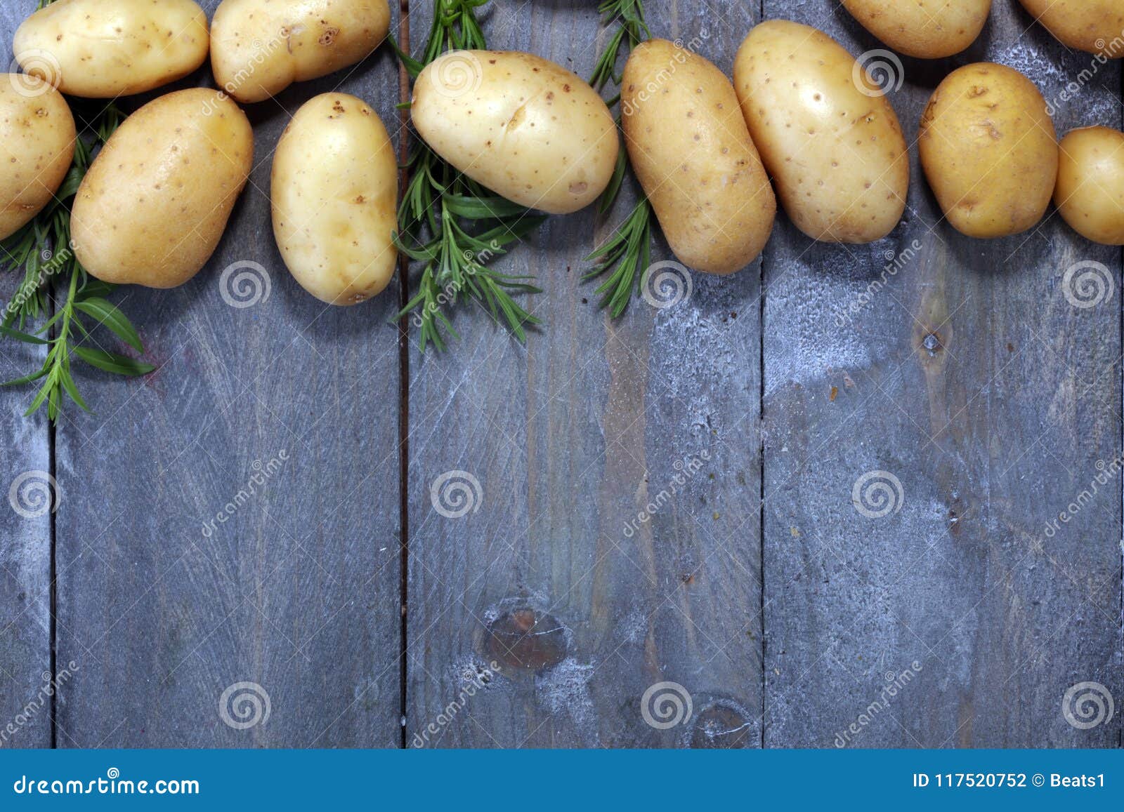 Pile of Potatoes Lying on Table. Fresh Potato and Rosemary Stock Photo ...