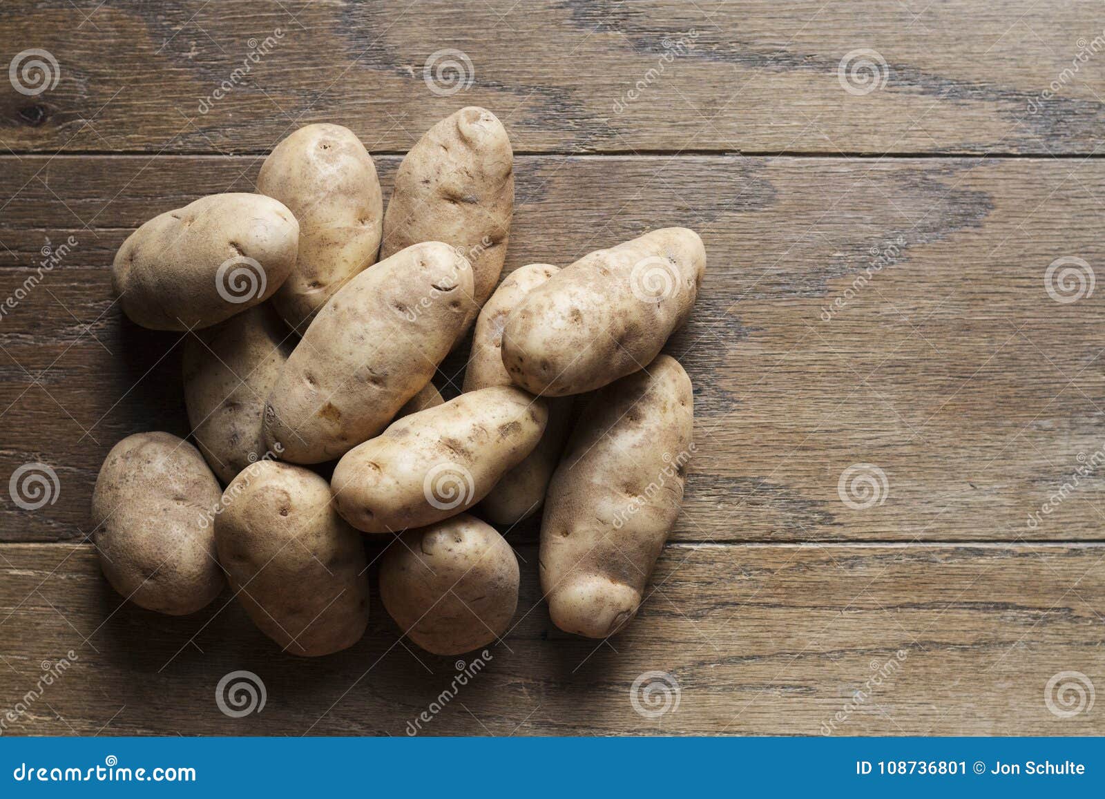 Pile Of Potatoes Lying On Wooden Boards. Fresh Healthy Potato Royalty ...