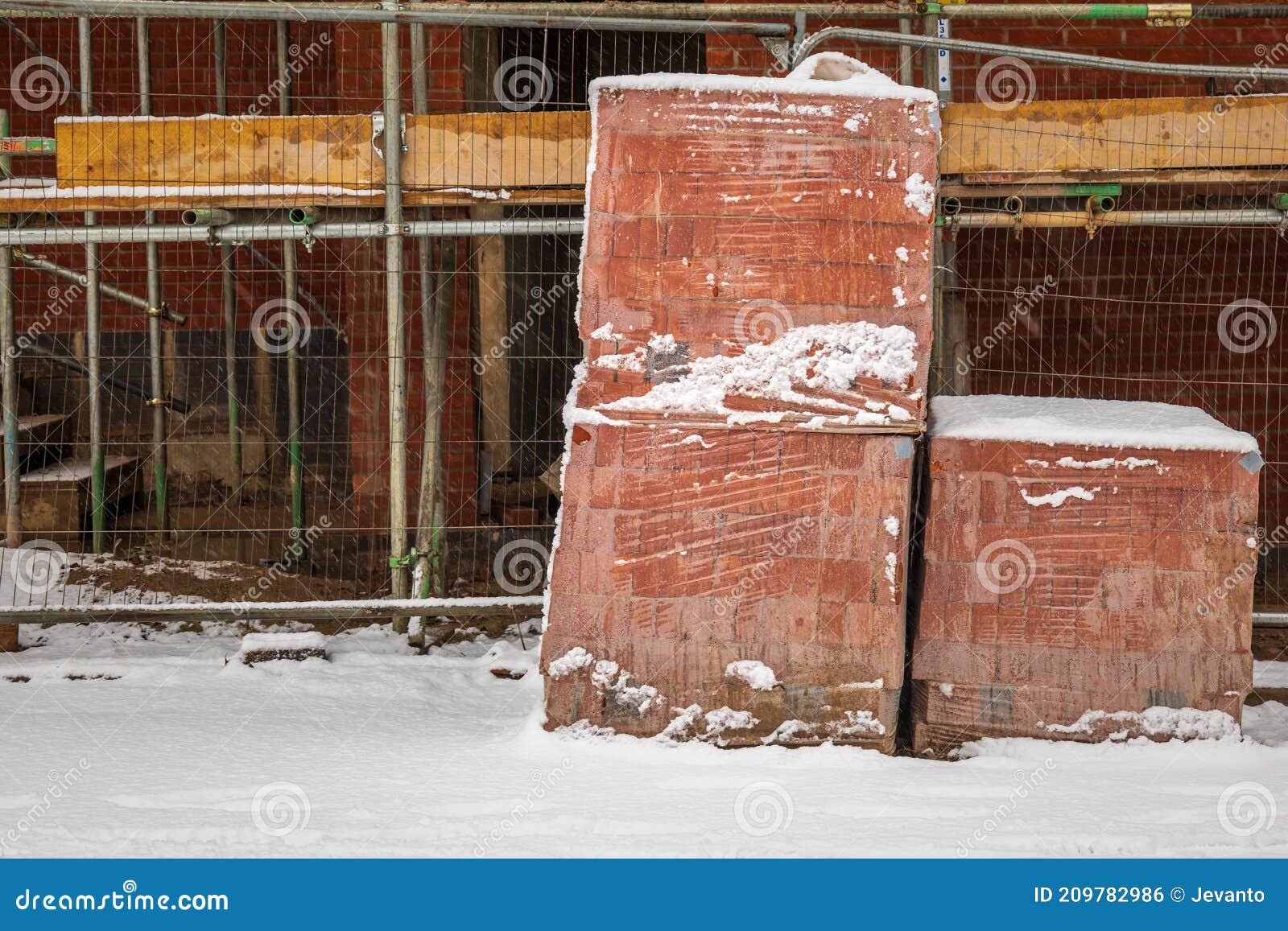 Pile of Red Building Construction Bricks Under Winter Snow in England ...