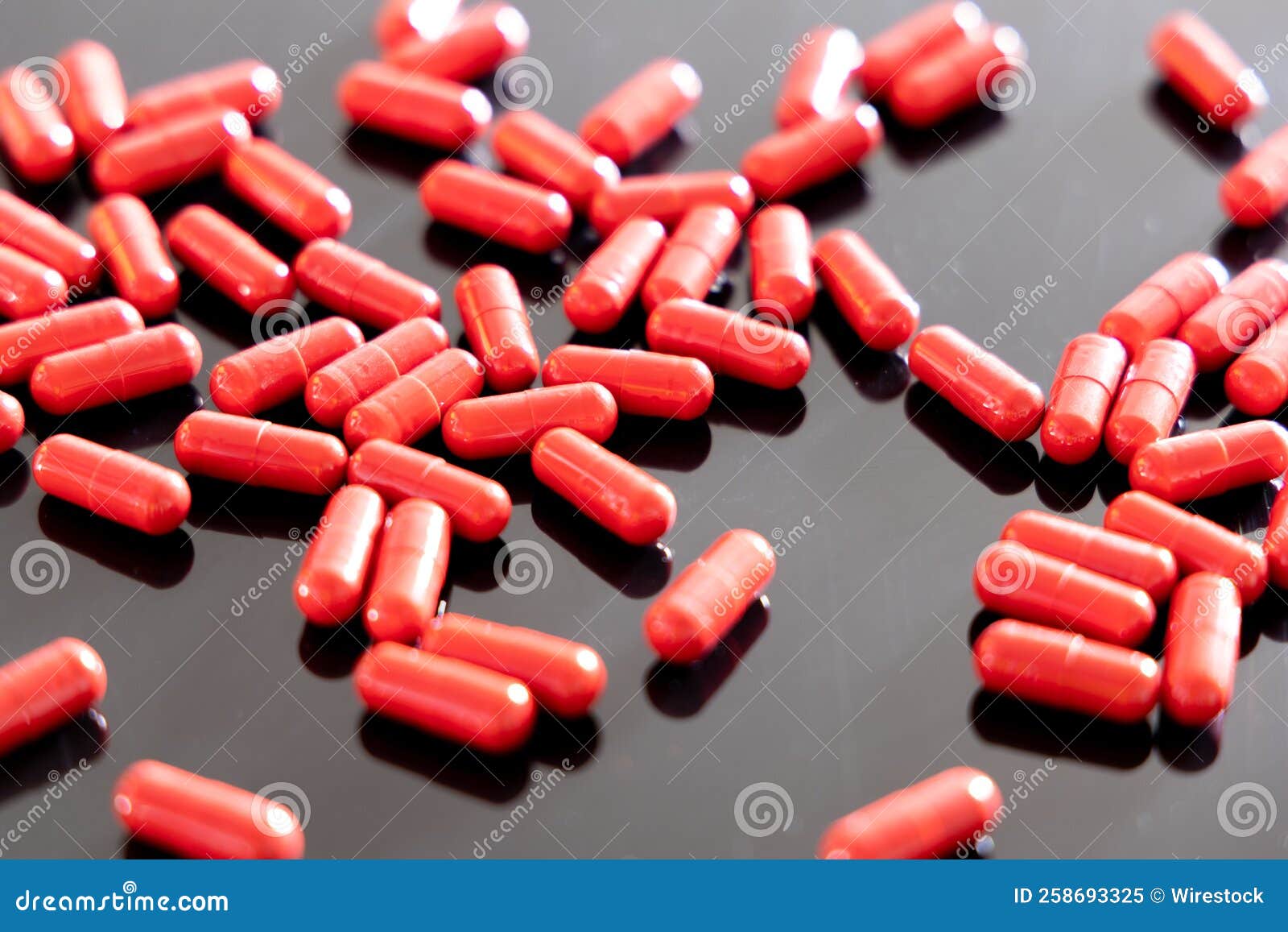 Pile of Red Capsules on Black Surface Stock Image - Image of surface ...