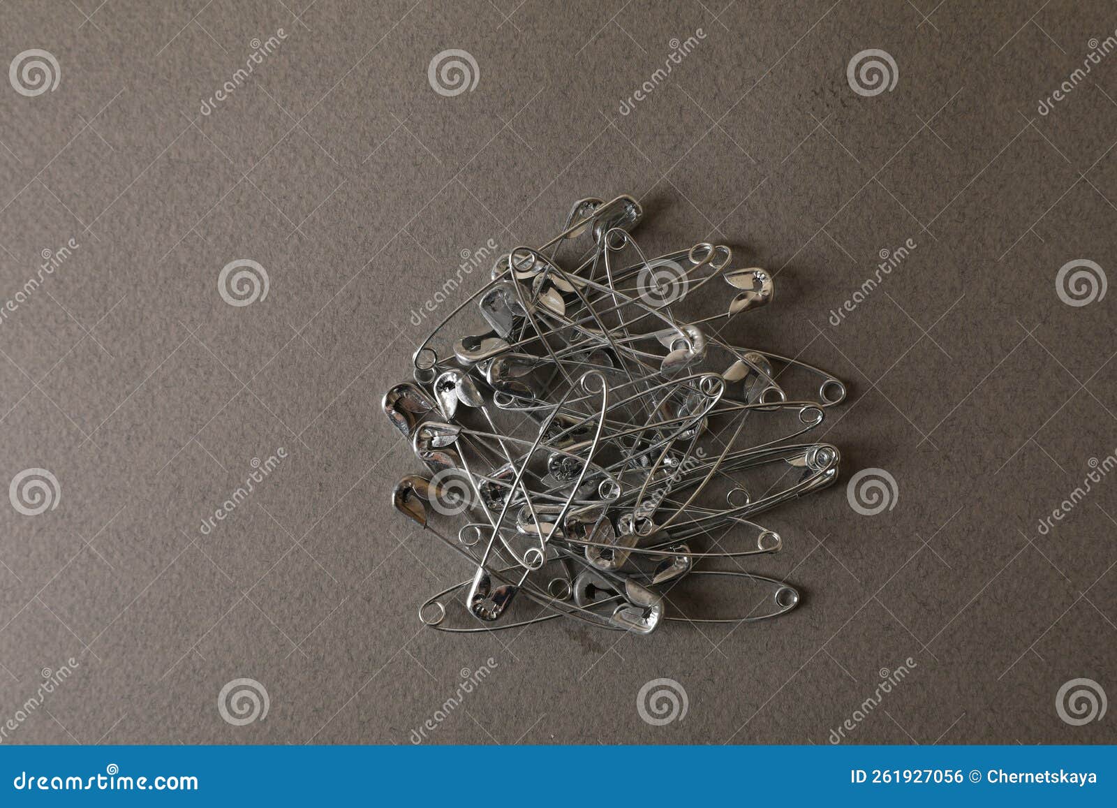 Pile of Safety Pins on Grey Textured Background, Flat Lay Stock Photo ...