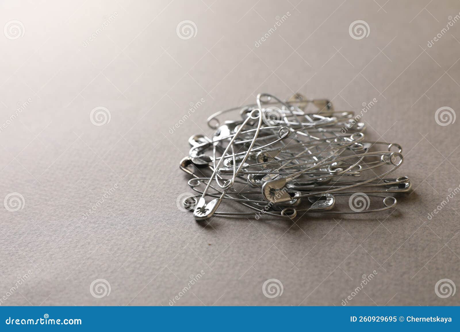 Pile of Safety Pins on Light Grey Textured Background, Space for Text ...