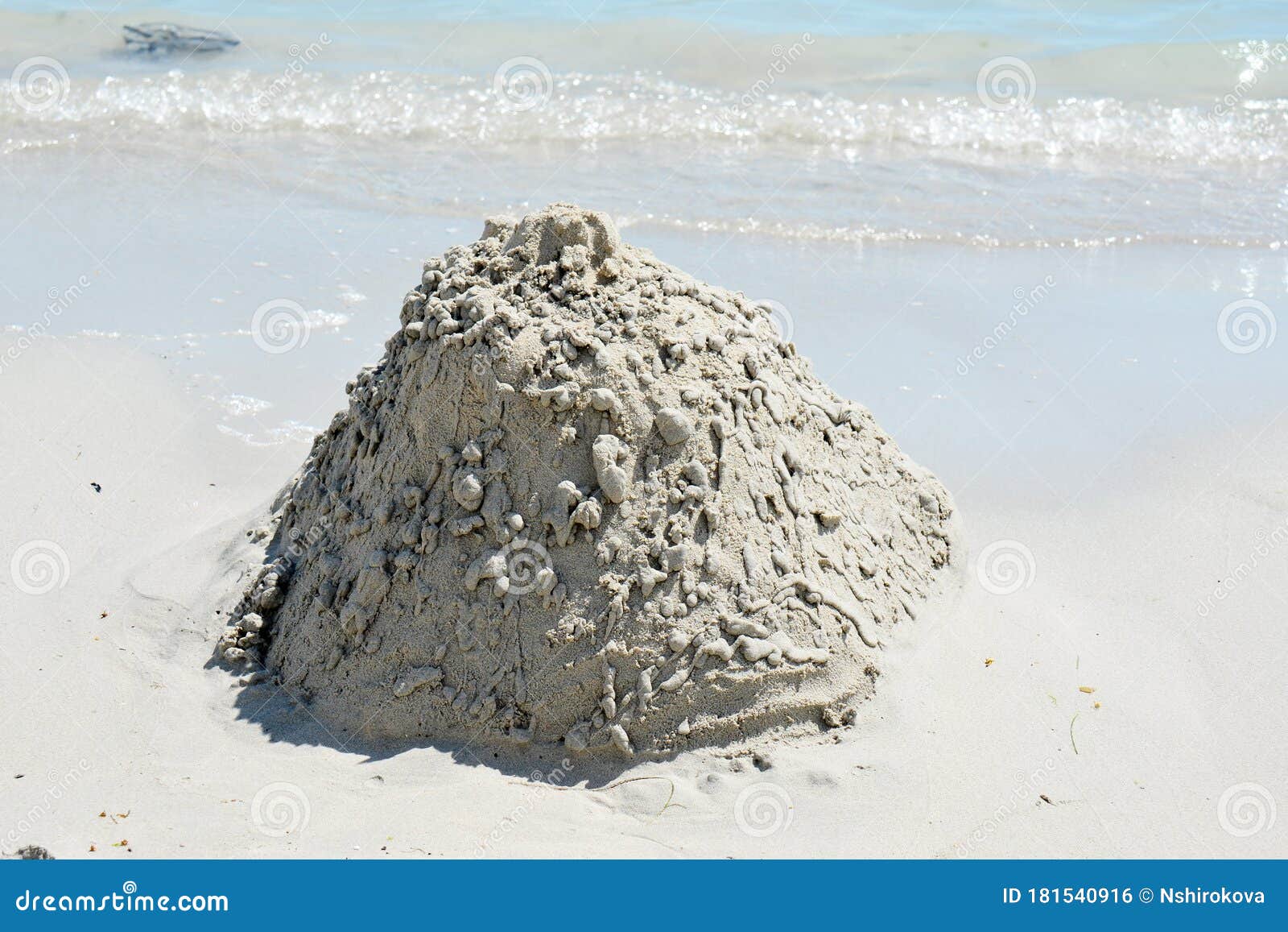 Pile of sand on the beach stock photo. Image of pyramid - 181540916