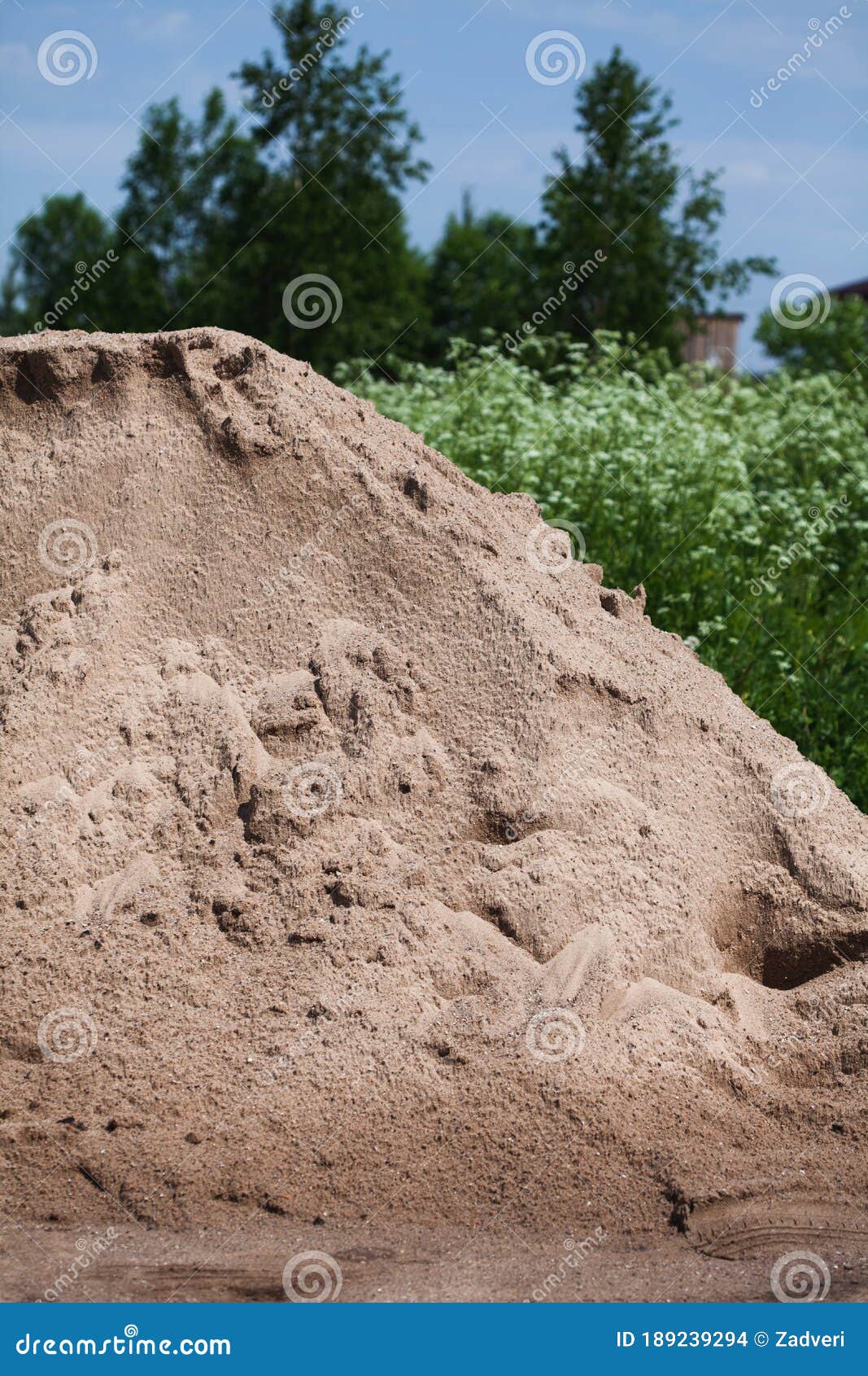 A Pile of Sand Poured into a Meadow for Construction Stock Photo ...
