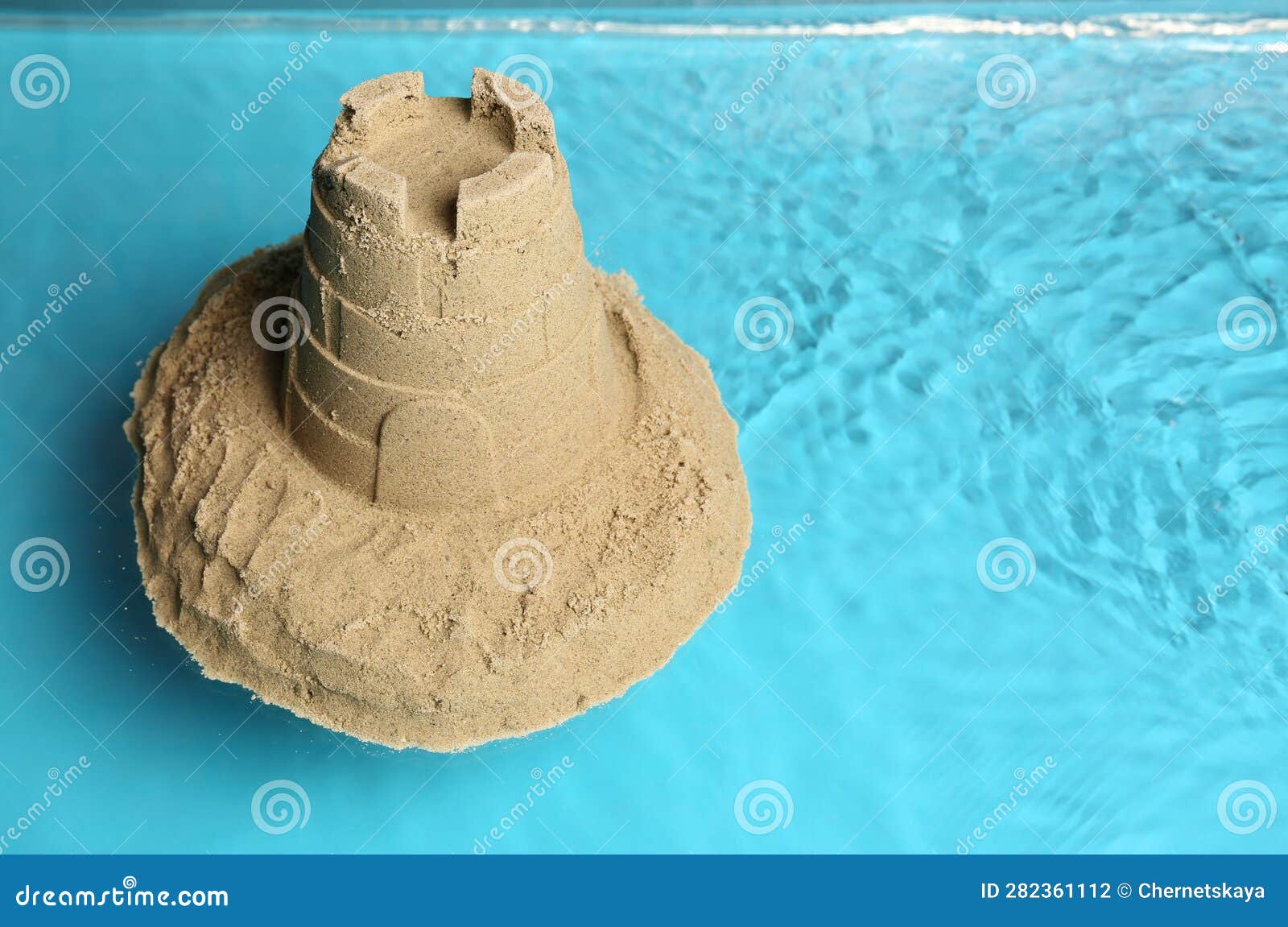 Pile of Sand with Tower on Rippled Water, Space for Text. Beautiful ...