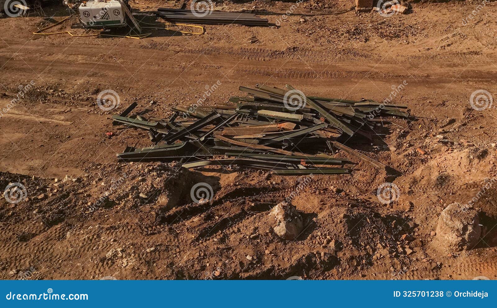 A Pile of Scrap Metal Sits on a Dirt Road at a Construction Site Stock ...