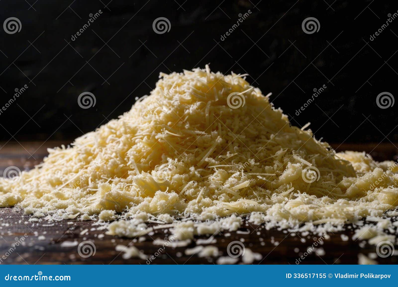 A Pile of Shredded Cheese Sits on Top of a Wooden Table, Ready for Use ...