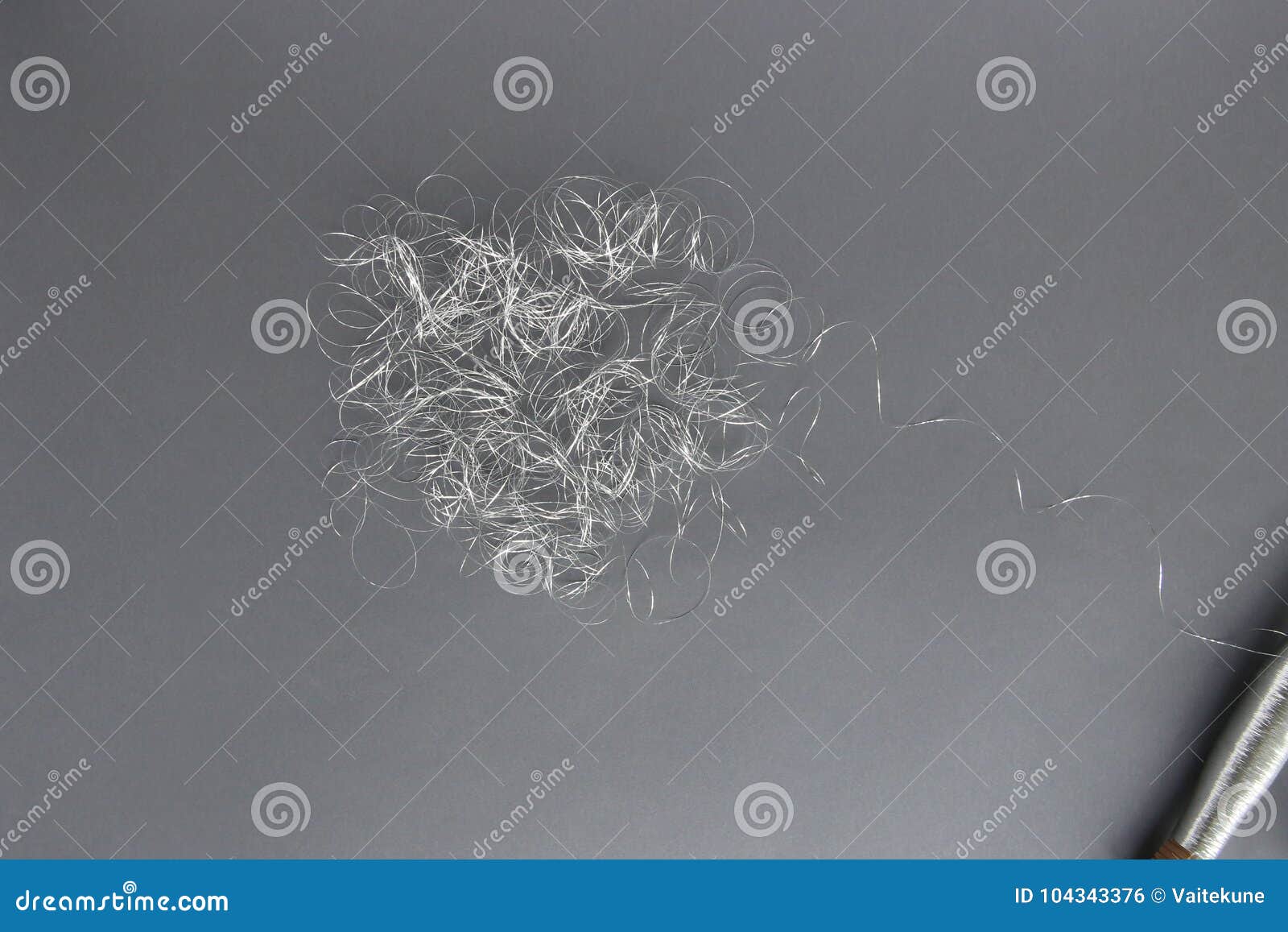 Silver Thread Pile Like Cloud and Spool of Silver Thread. Stock Photo ...