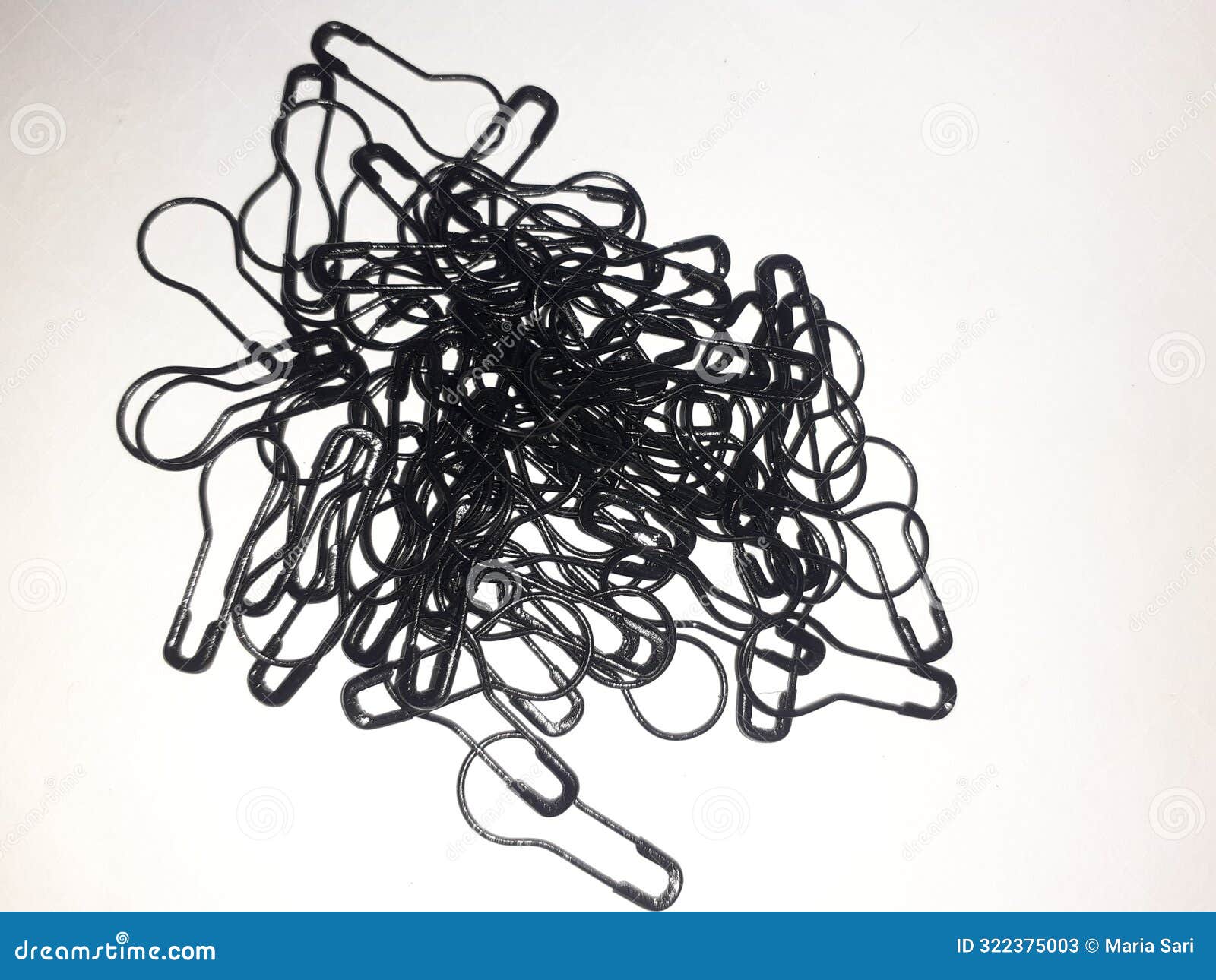 A Pile of Small Black Pins in the Shape of a Bulb, on a White ...