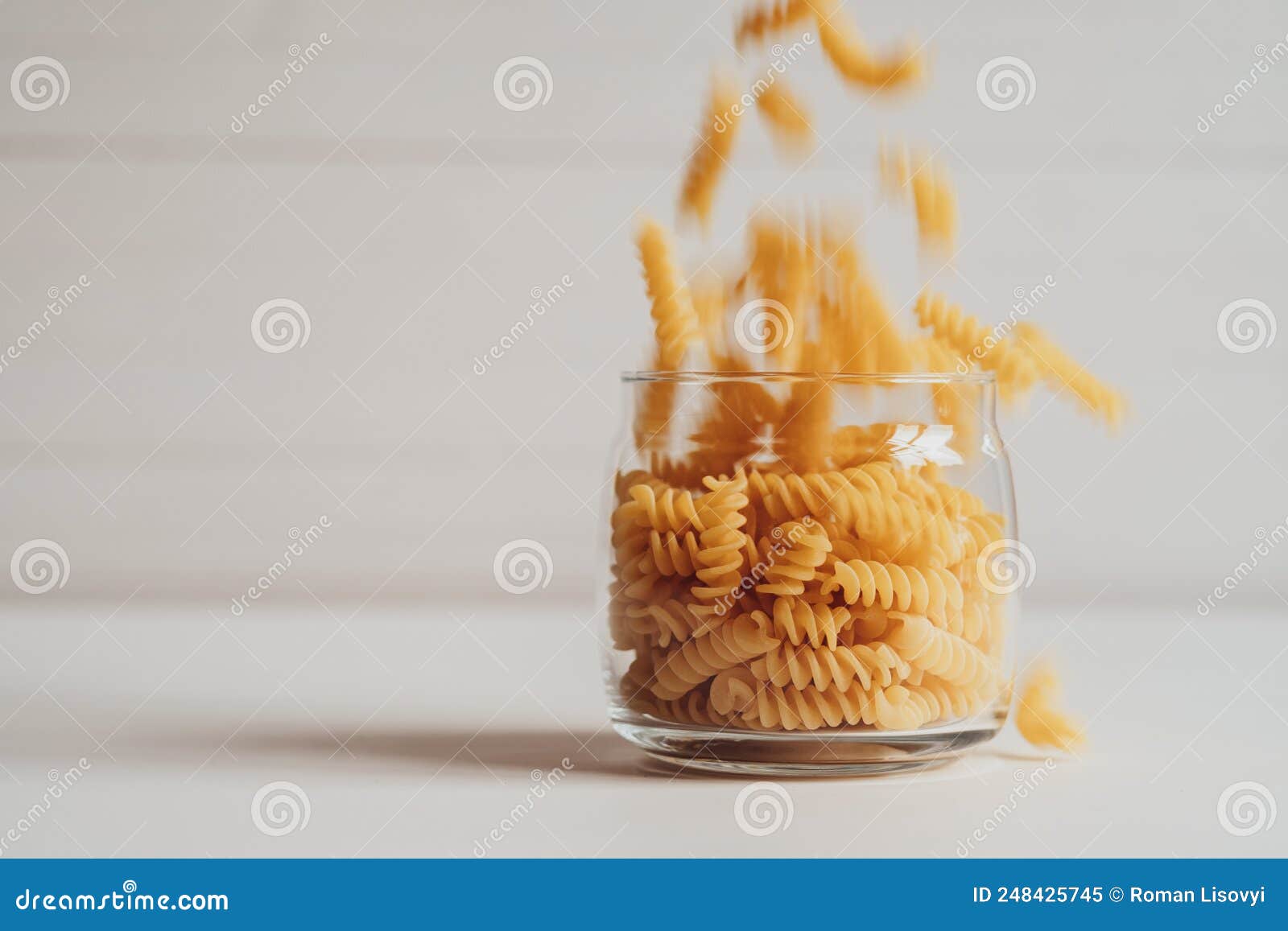 Pile of Wavy Pasta Dropped in Glass on a White Background Stock Image ...