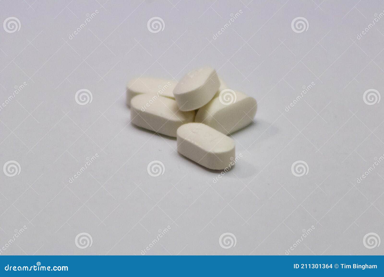 Pile of white tablets stock photo. Image of medical - 211301364