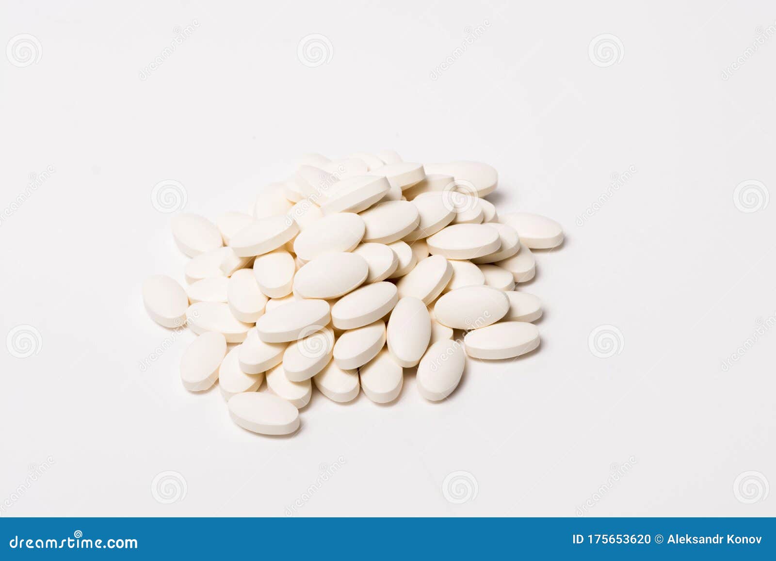 A Pile of White Oval-shaped Tablets on a White Background. View from ...