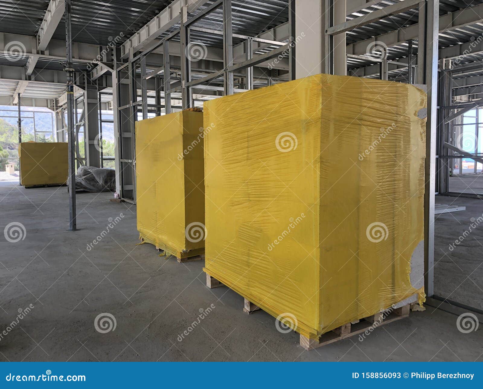 Piled Cinder Blocks Wrapped in Yellow Packaging on the Floor of the ...