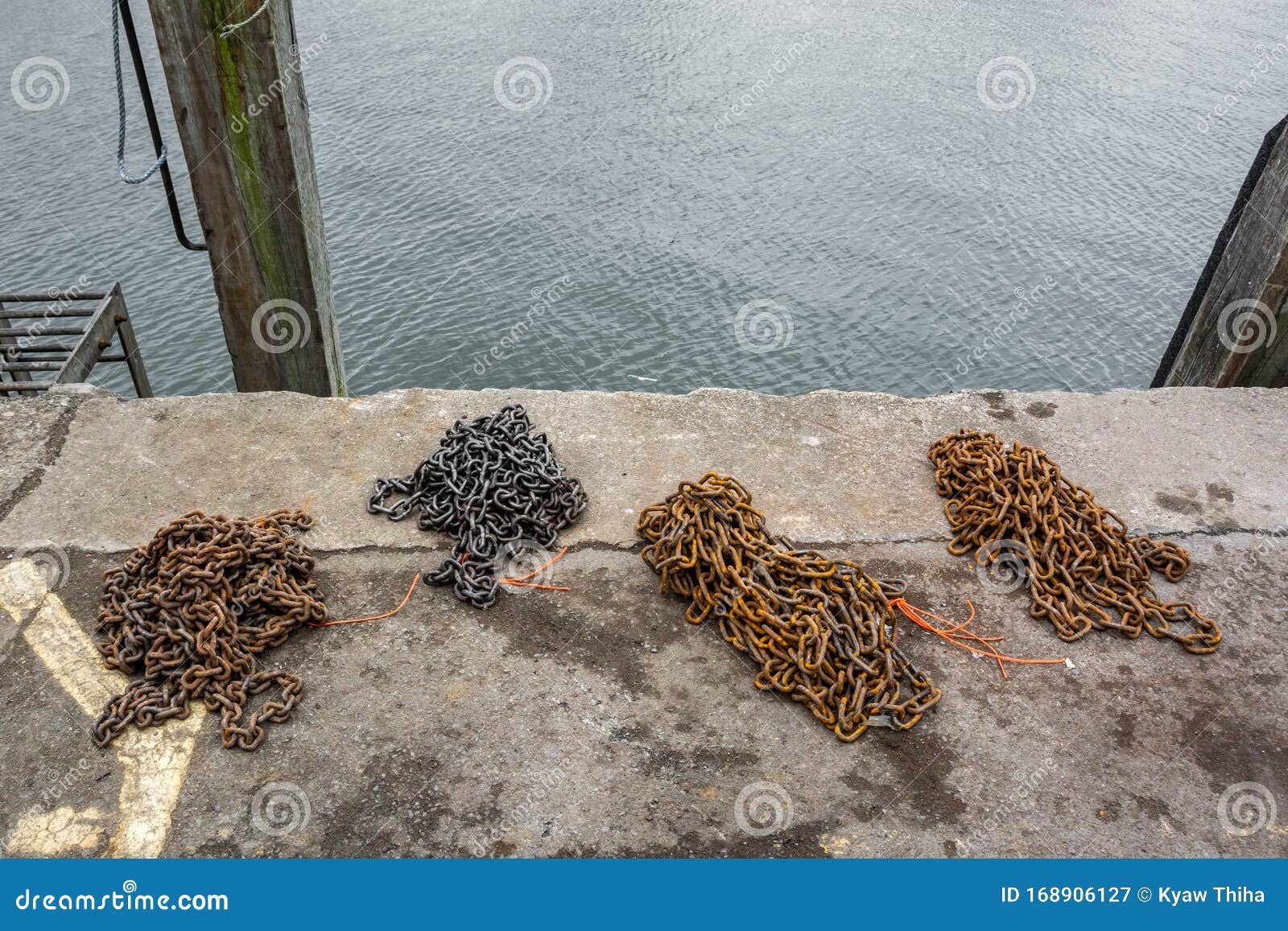 Piles of Anchor Chain on Concrete Dock Stock Image - Image of chain ...