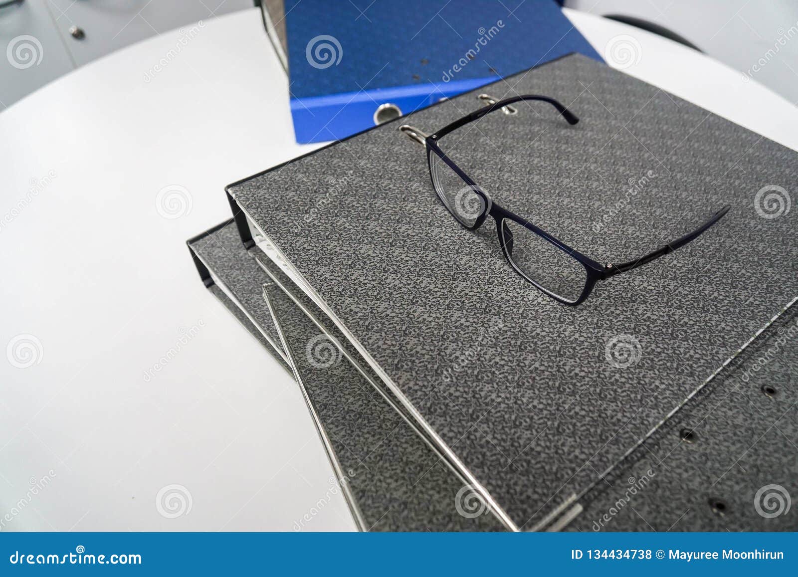 Business Folders with Eye Glasses on Top in Workplace Stock Photo ...