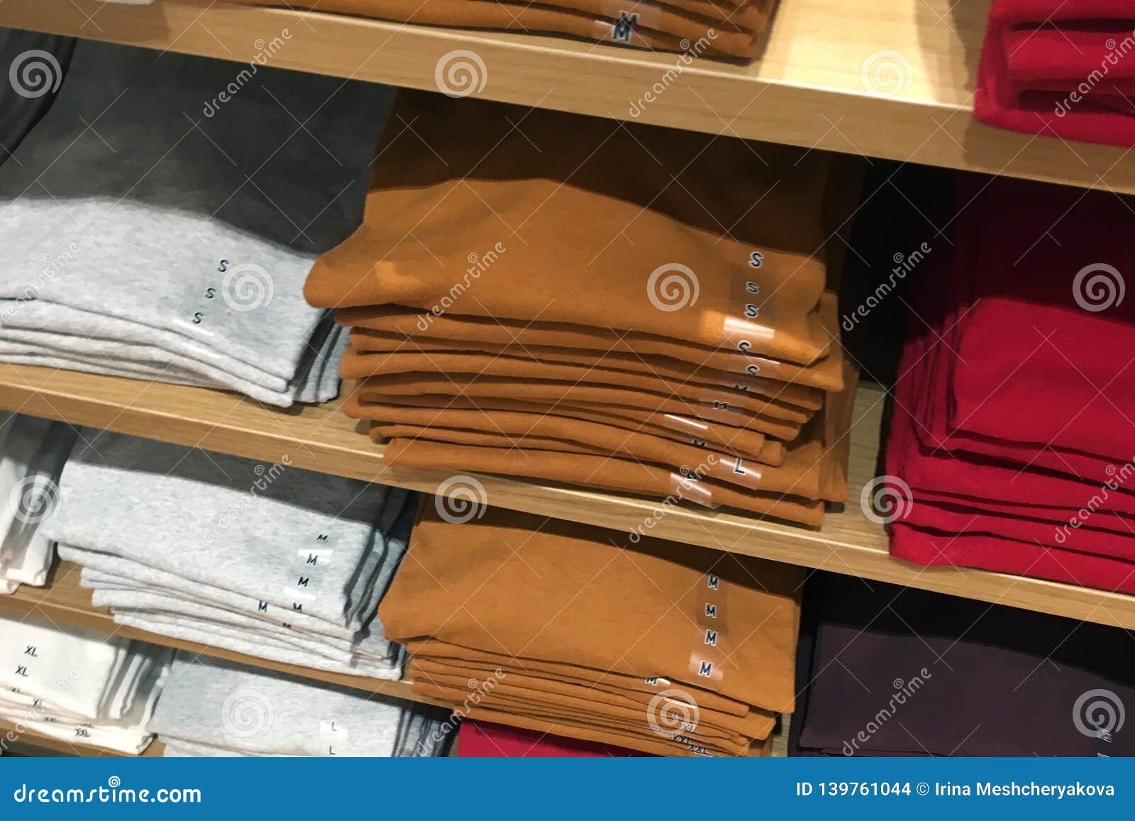 Piles of Multi Colored Clothes on the Shelves in the Store. Stack of ...