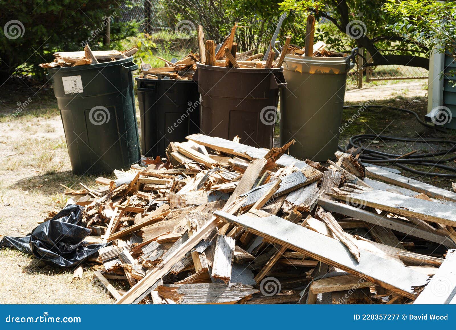 Piles of Wood on Ground and in Garbage Pails from Removing a Deck Stock ...