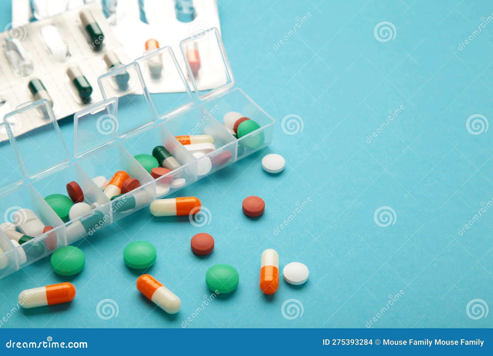 Daily Pill Box with Medications and Nutritional Supplements on Blue ...