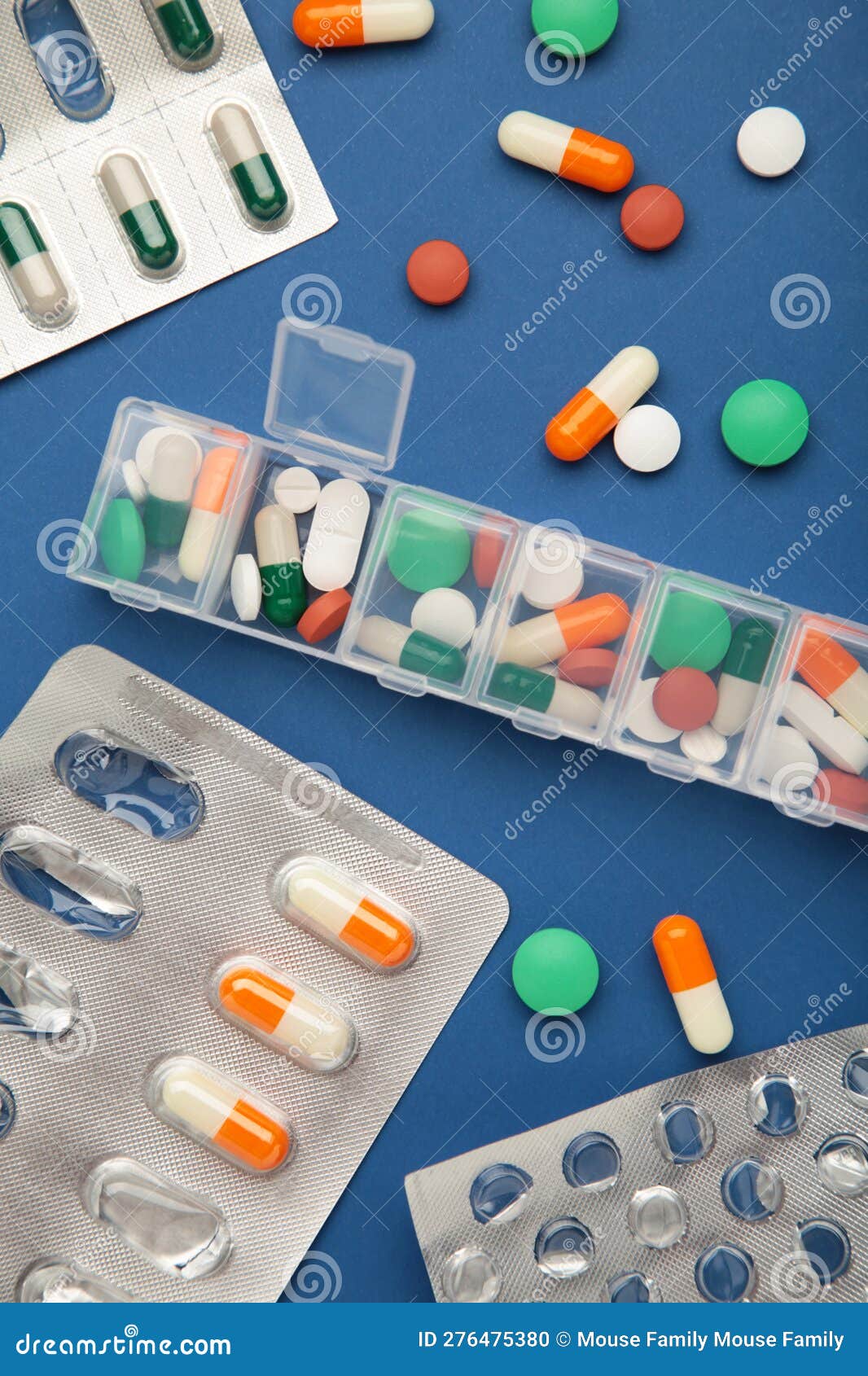 Daily Pill Box with Medications and Nutritional Supplements on Blue ...