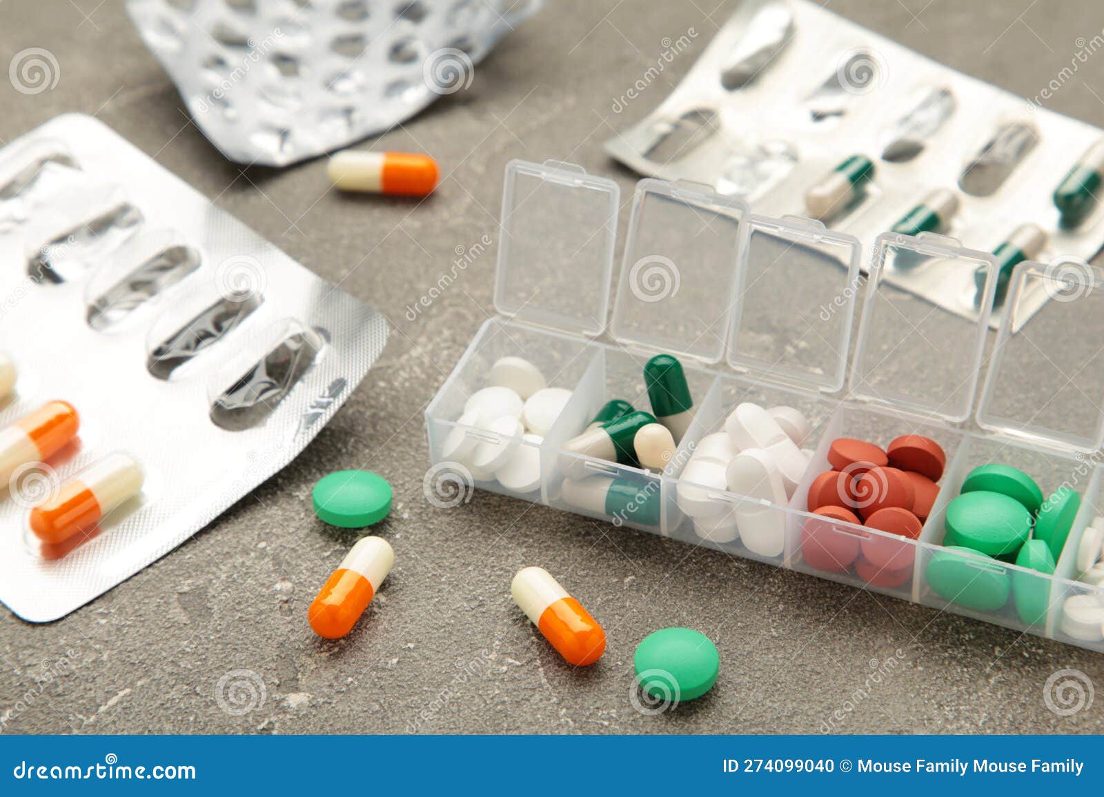 Daily Pill Box with Medications and Nutritional Supplements on Grey ...