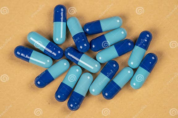 Pill Capsules and Two Shades of Blue Stock Photo - Image of background ...