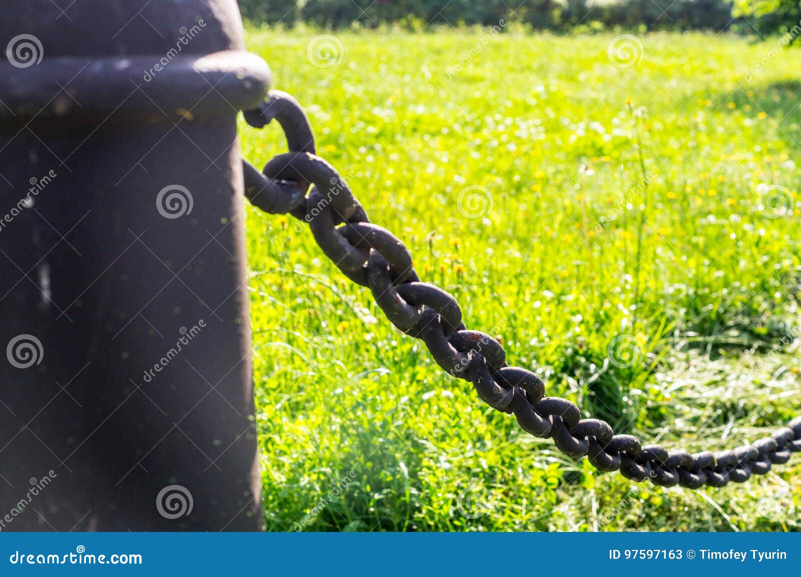 Pillar with Iron Chain on Grass Background. Industrial, Nature. Stock ...