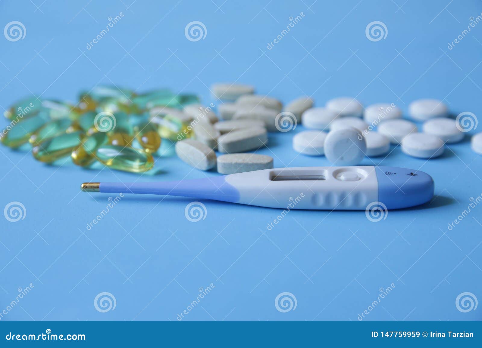 Pills, Capsules and a Thermometer for Measuring Body Temperature on a ...