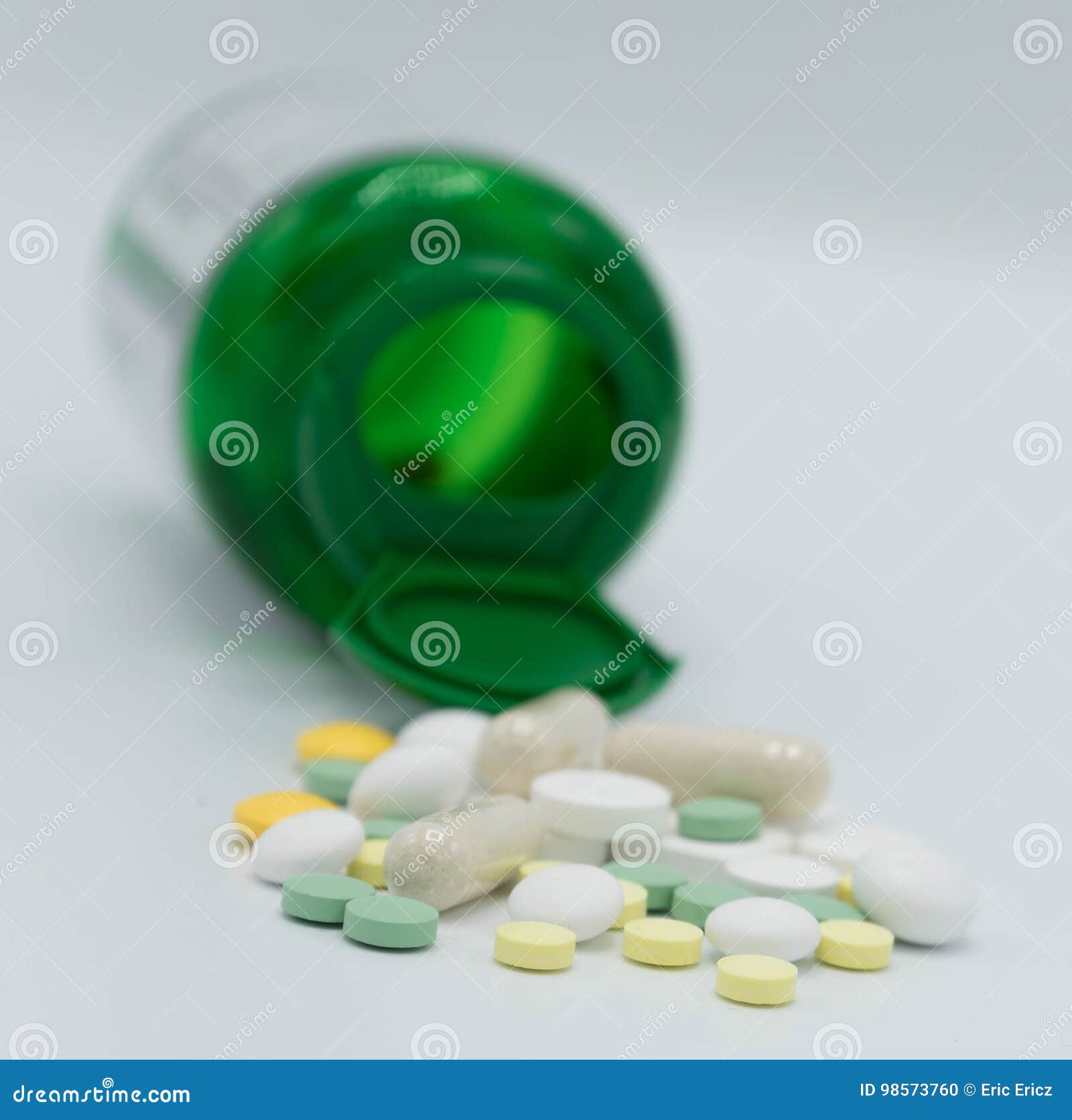 Pills Falling Out a Green Bottle. Stock Photo - Image of capsule, care ...
