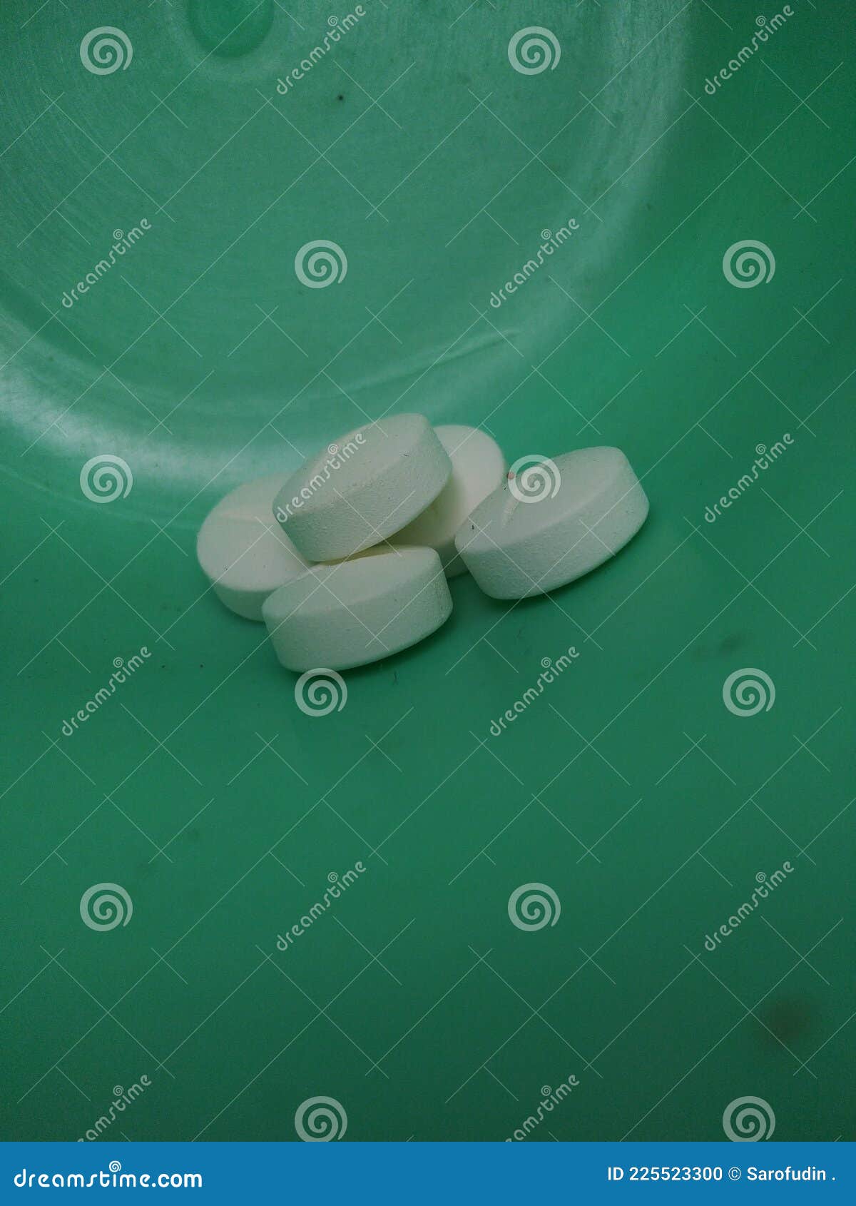 Pills in green container stock photo. Image of lighting - 225523300