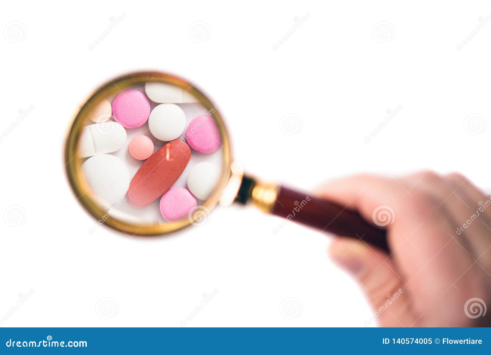 Pills Under a Magnifying Glass on the White Background. Stock Image ...