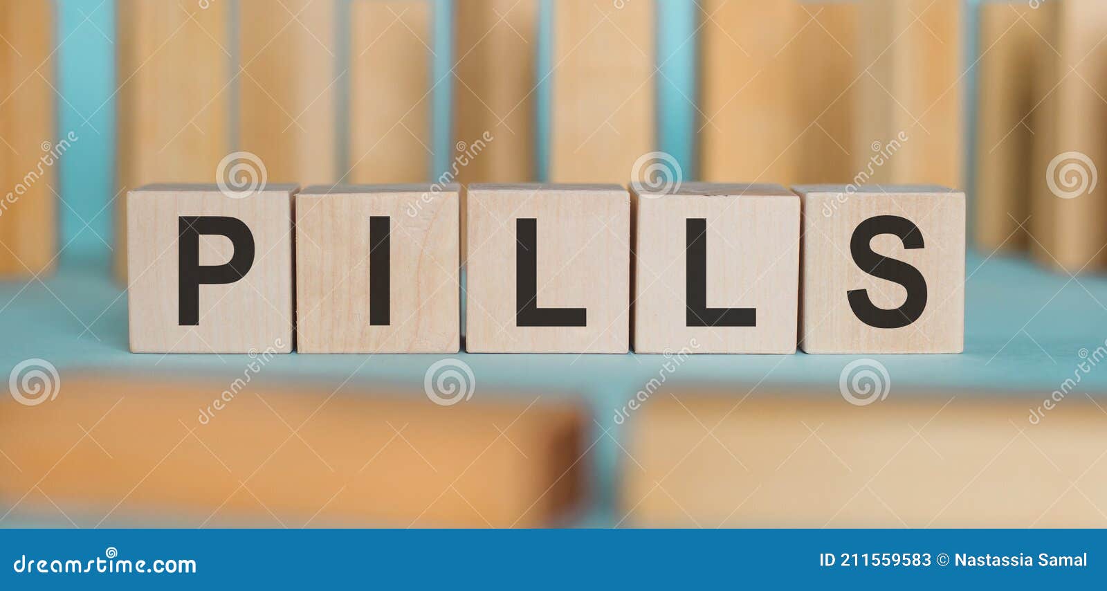 PILLS Word Written on Wooden Blocks on Light Blue Background Stock ...