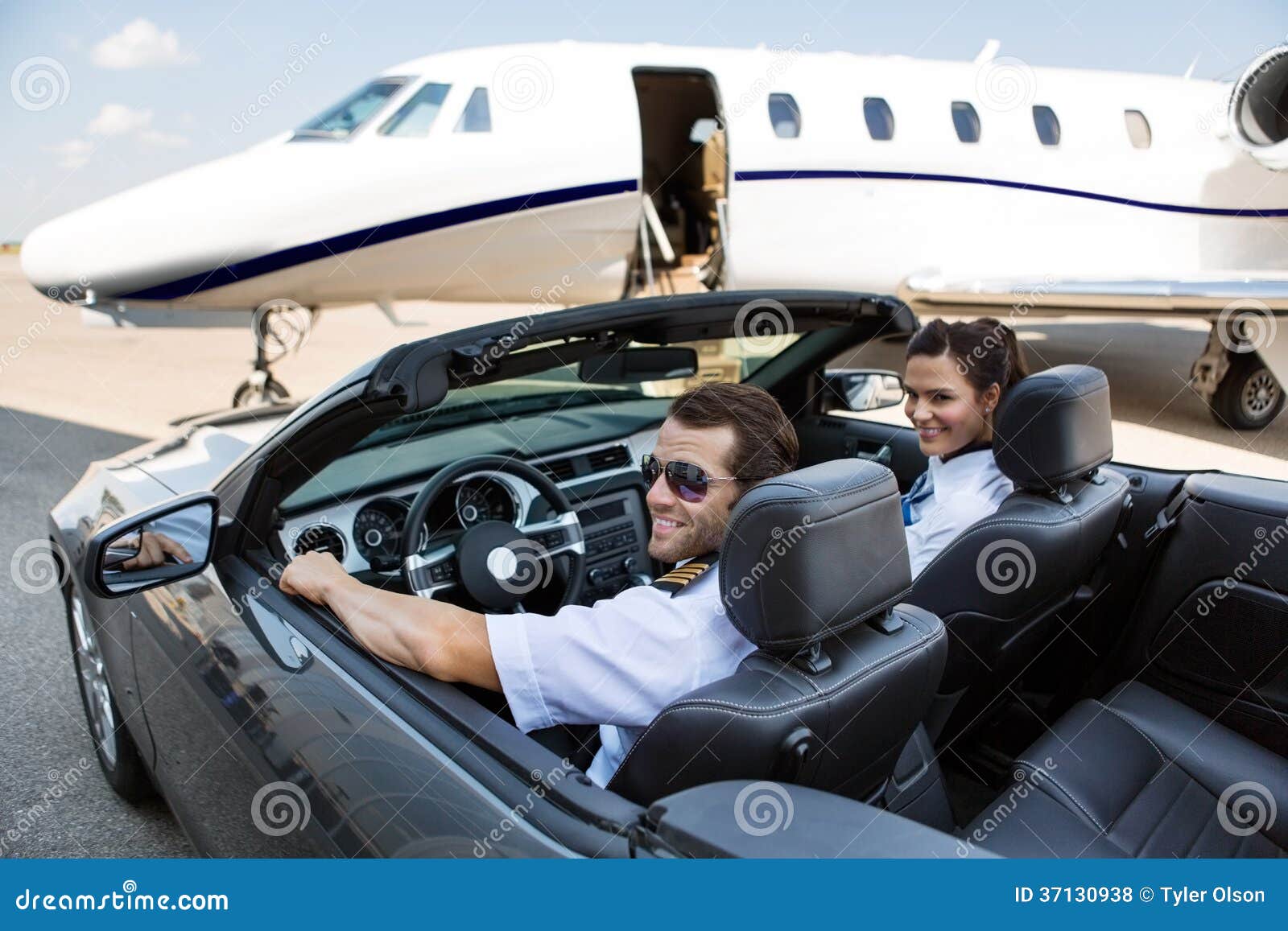 Pilot and Airhostess in Convertible Against Stock Photo - Image of ...