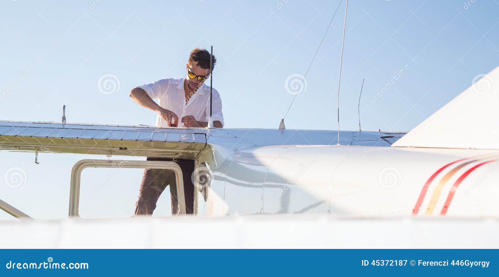 Pilot with Airplane Checking Fuel Level Stock Image - Image of outdoor ...