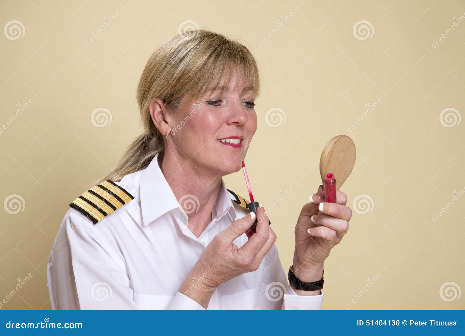 Pilot applying lip gloss stock photo. Image of aviator - 51404130