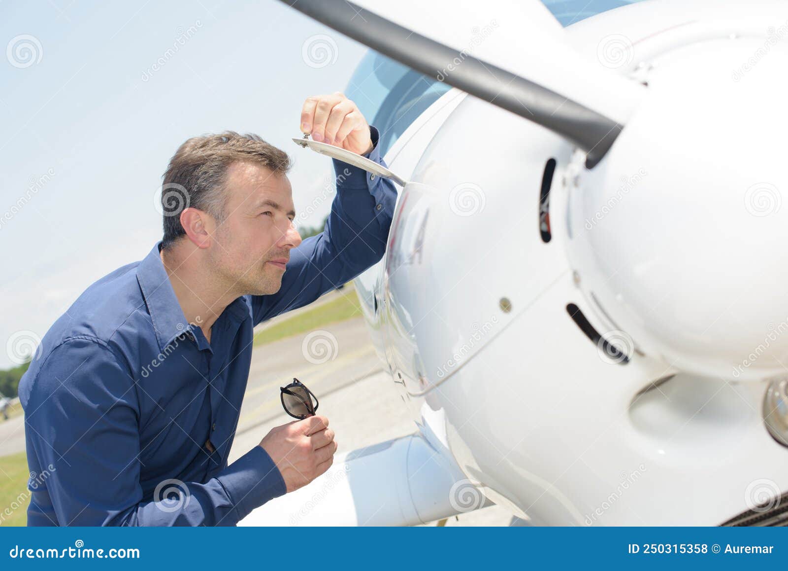 Pilot checking aircraft stock photo. Image of safety - 250315358
