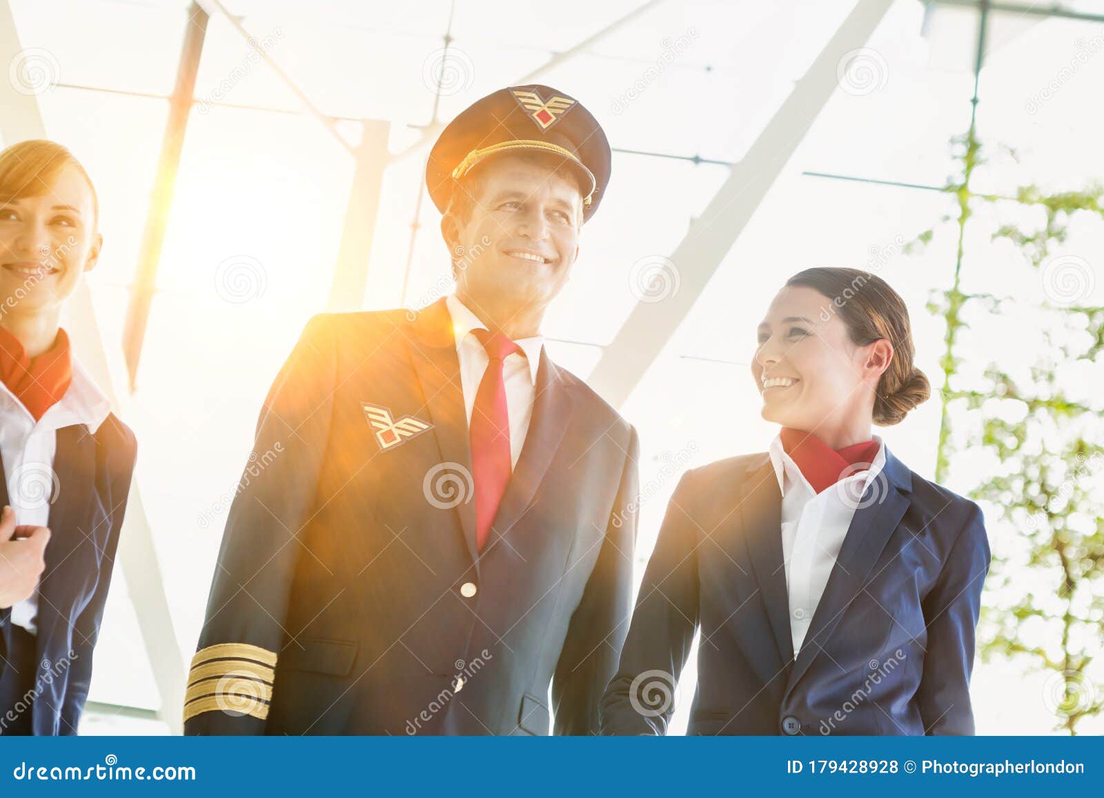 Pilot with Flight Attendants Walking in the Airport Stock Photo - Image ...